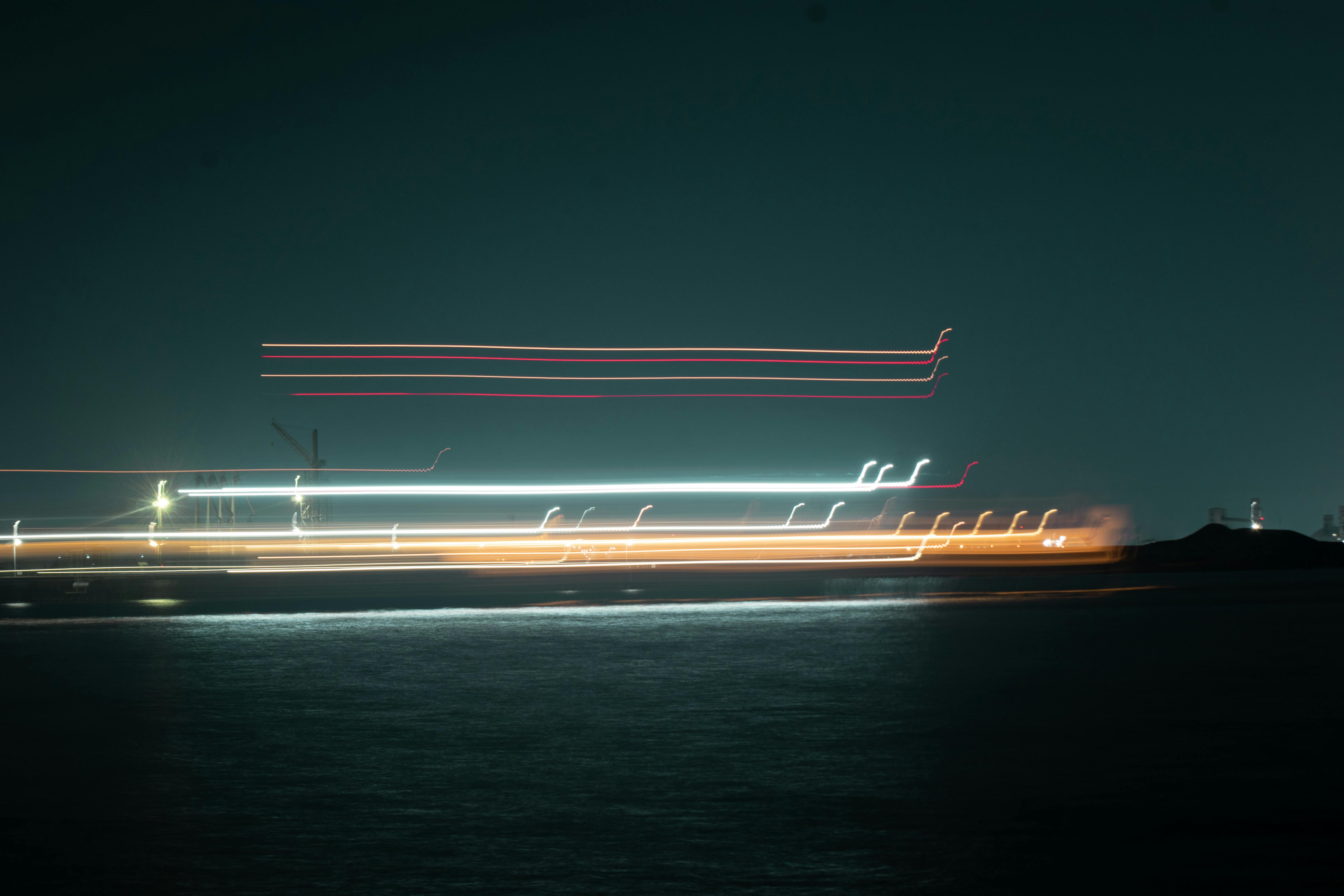 Lights Stripes over Water at Night · Free Stock Photo