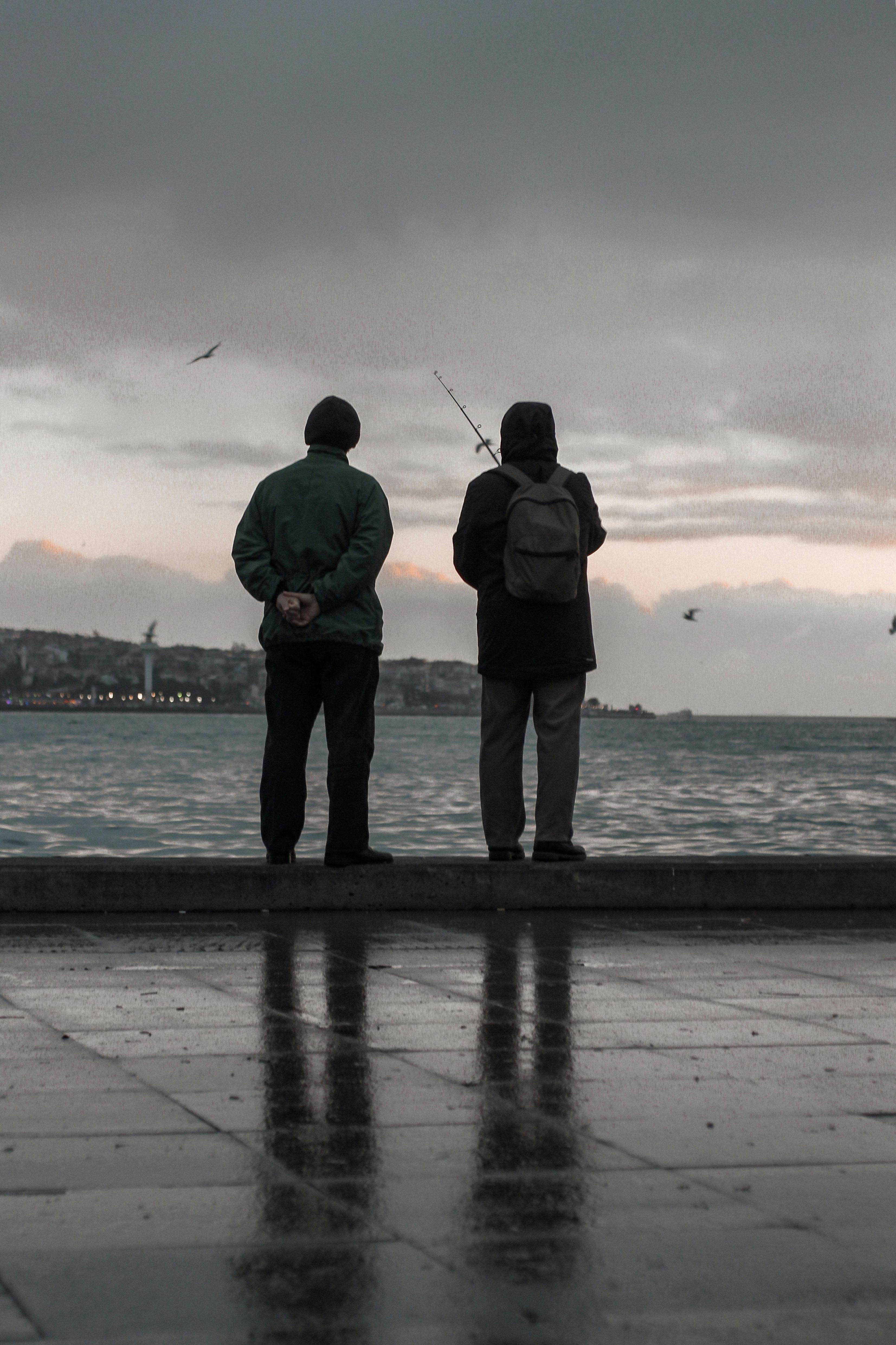 People Standing and Fishing on Sea Shore in City · Free Stock Photo