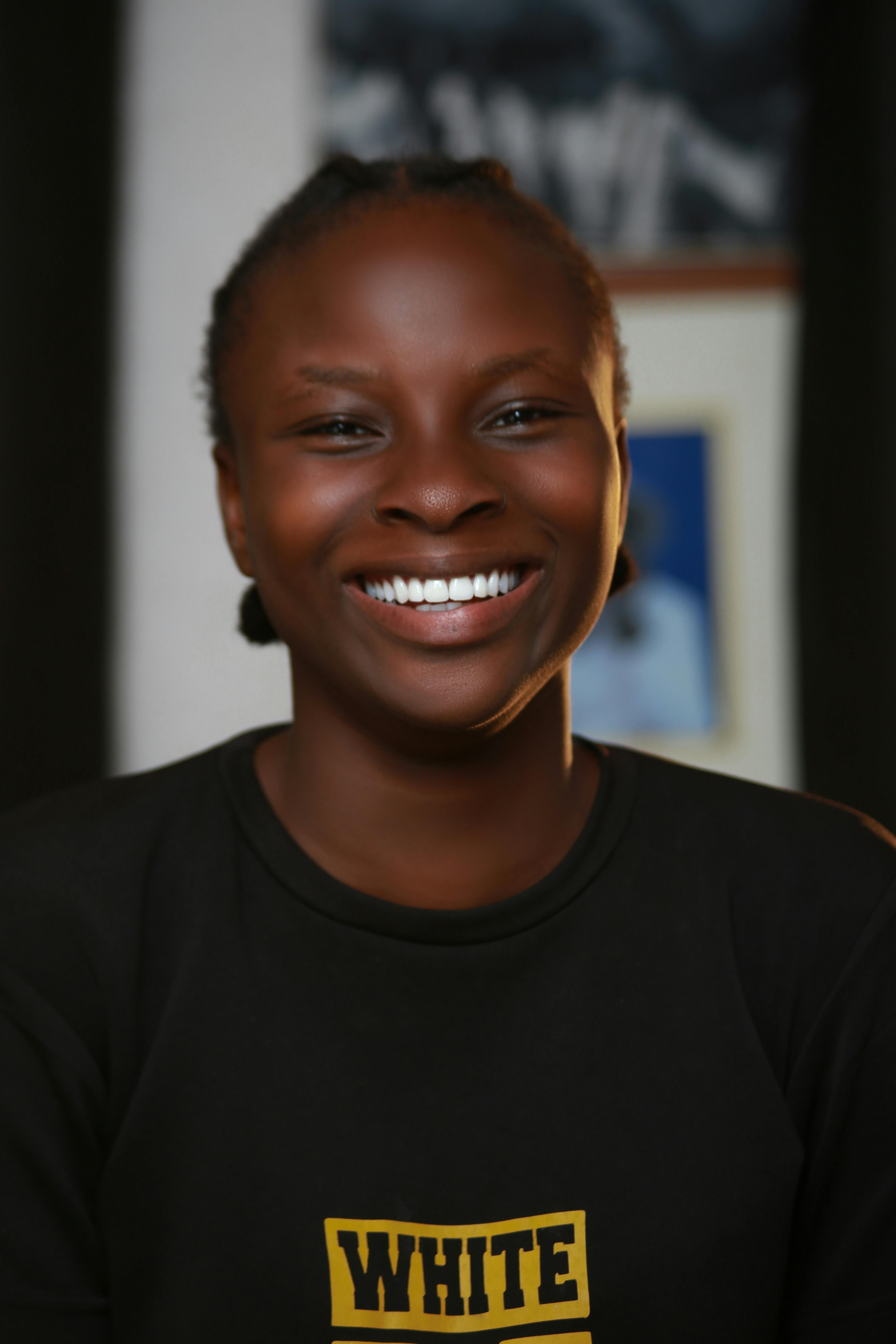 Smiling Young Woman in Shorts and T-shirt · Free Stock Photo