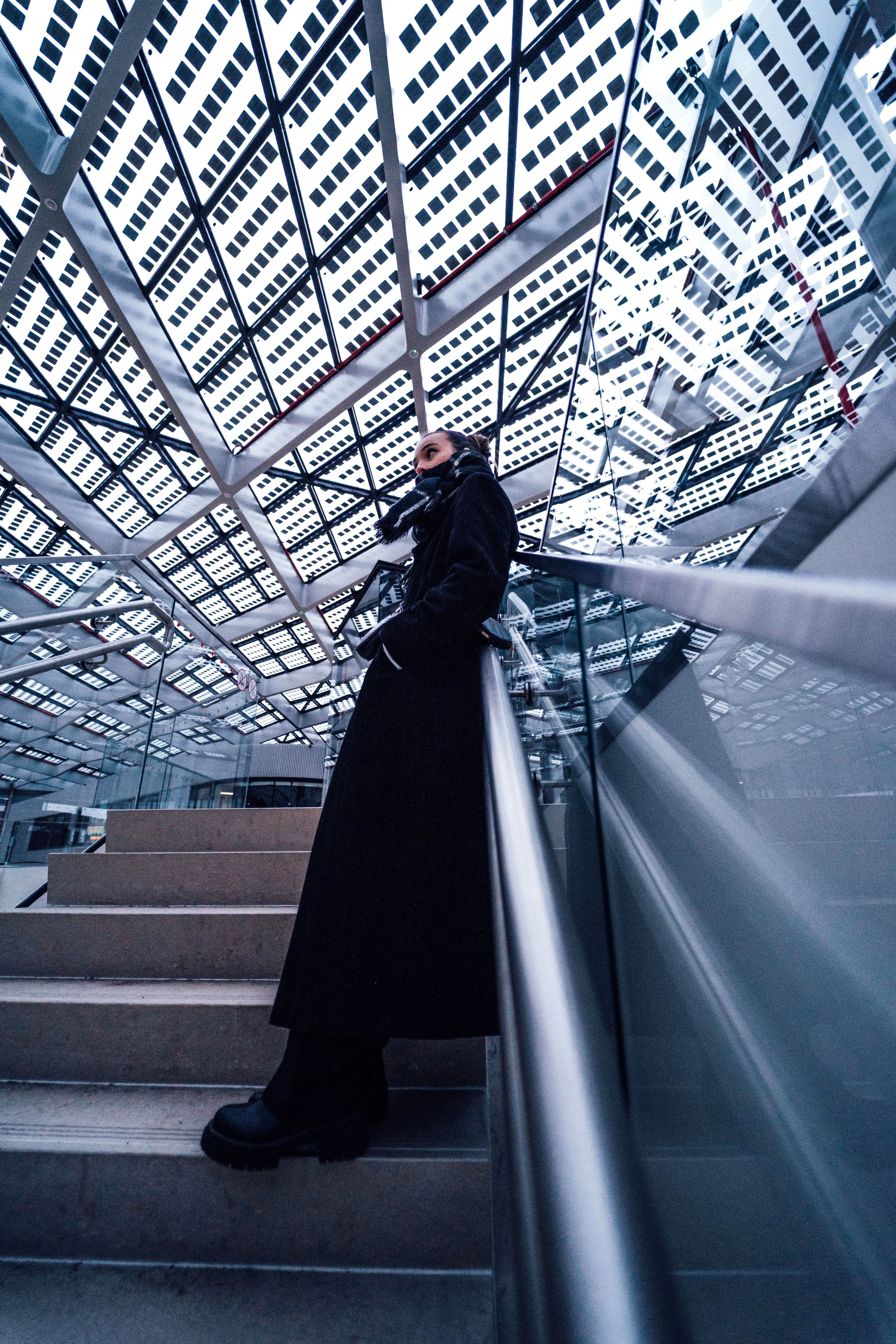 Low Angle View of a Woman Standing and Leaning on the Stairs · Free ...