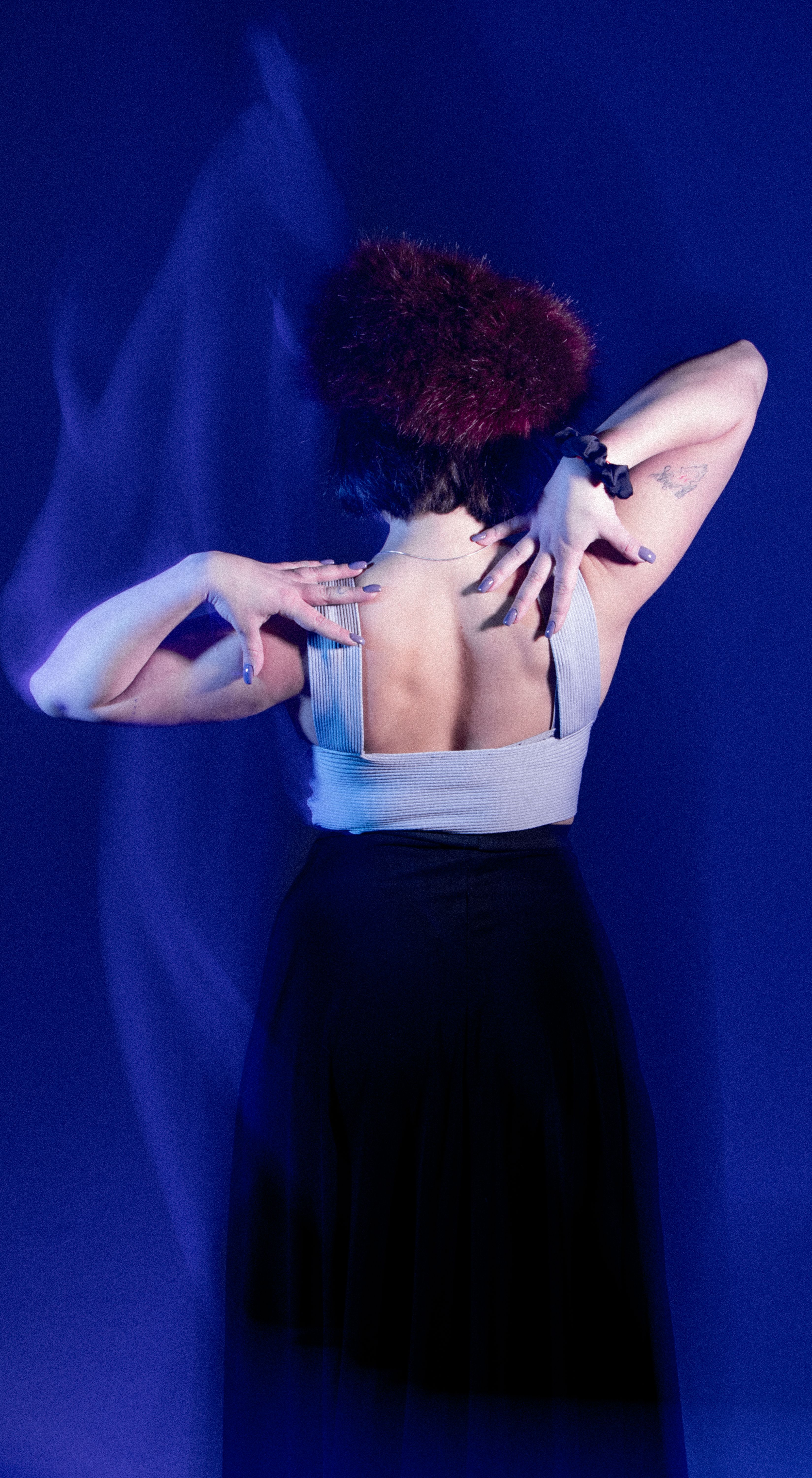 Back View of a Woman Touching her Shoulder Blades · Free Stock Photo