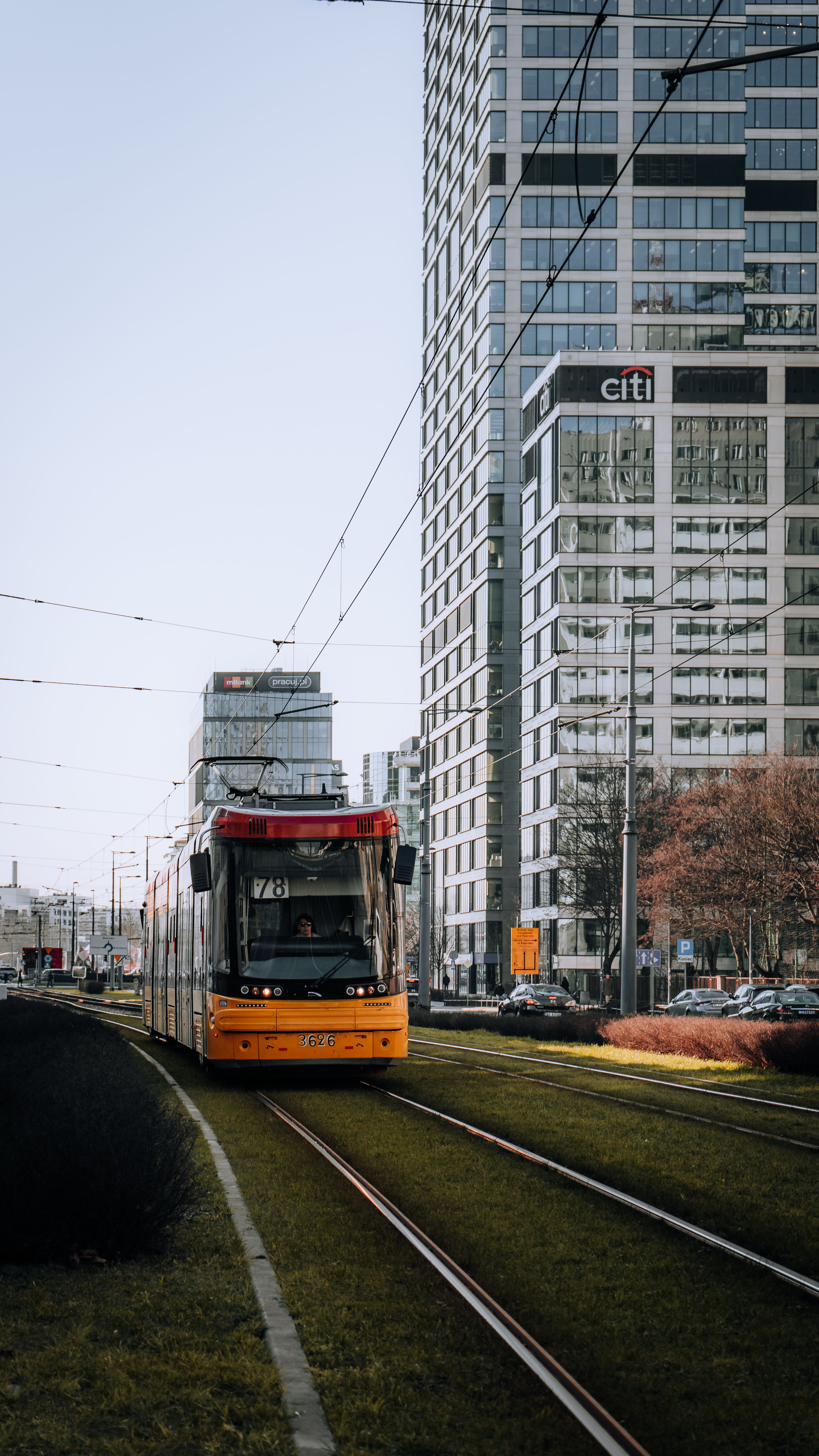 A train traveling down a track next to tall buildings · Free Stock Photo
