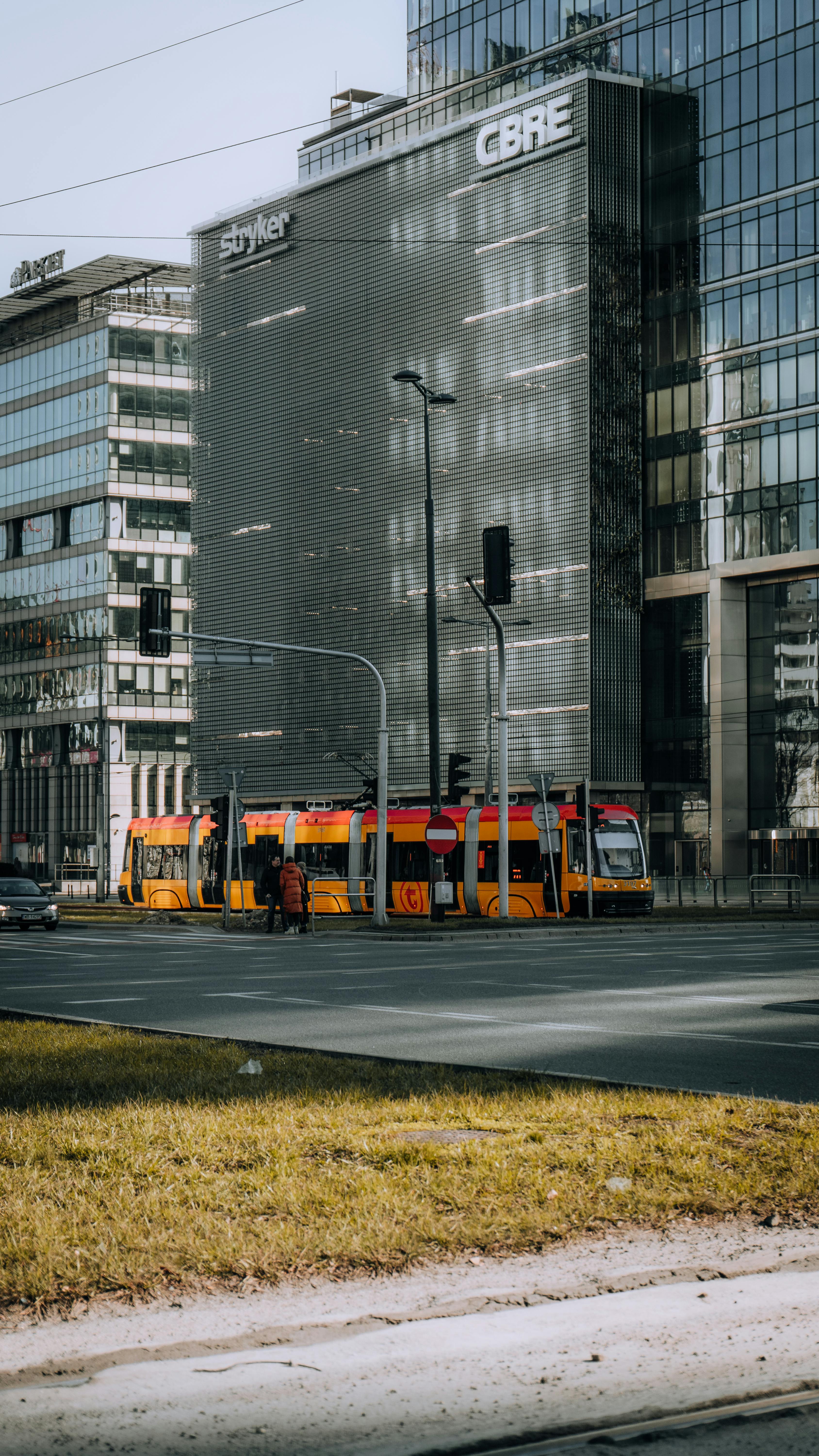 A city street with a bus and a building · Free Stock Photo