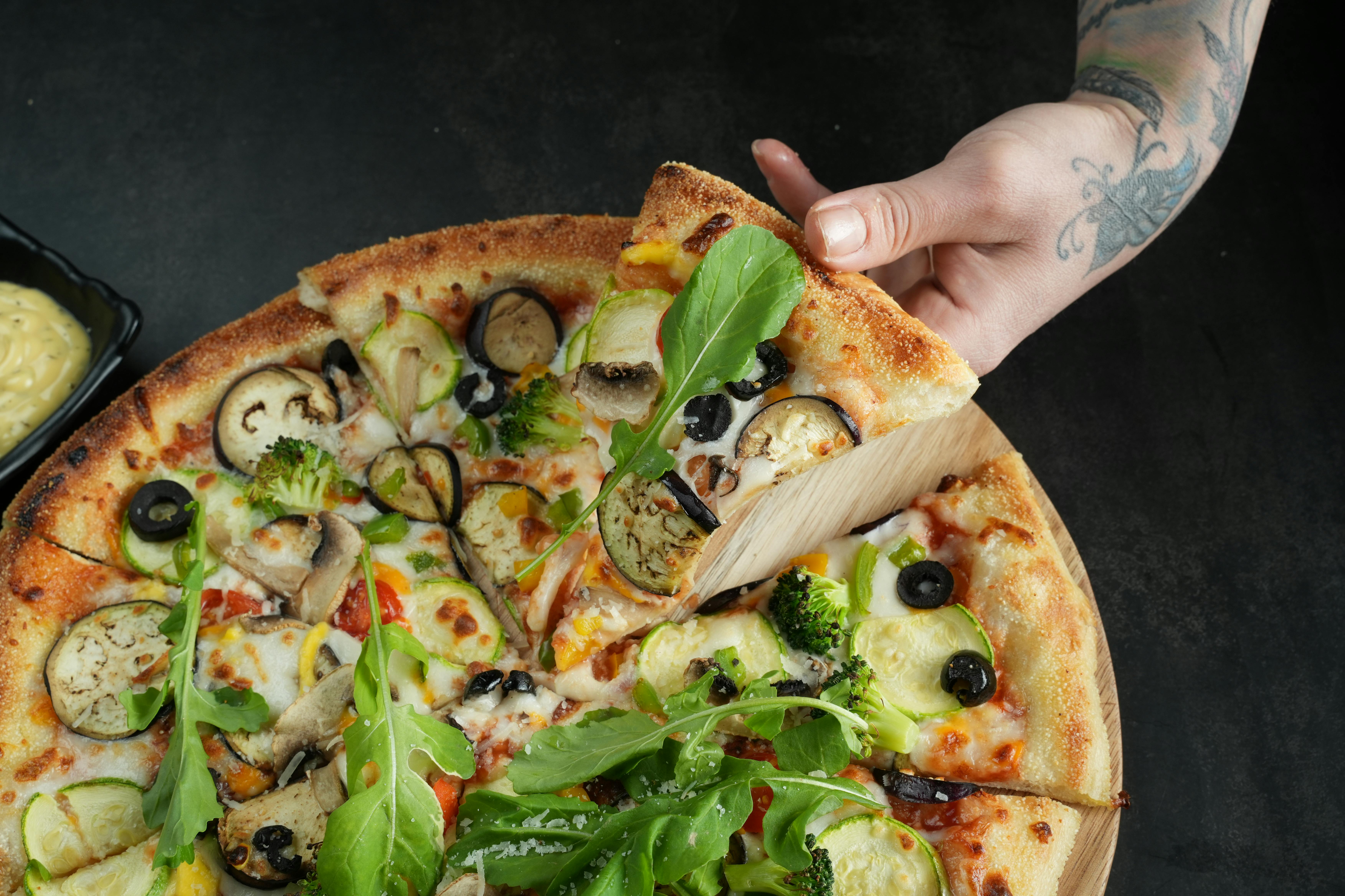 Hand of a Person Eating a Pizza · Free Stock Photo