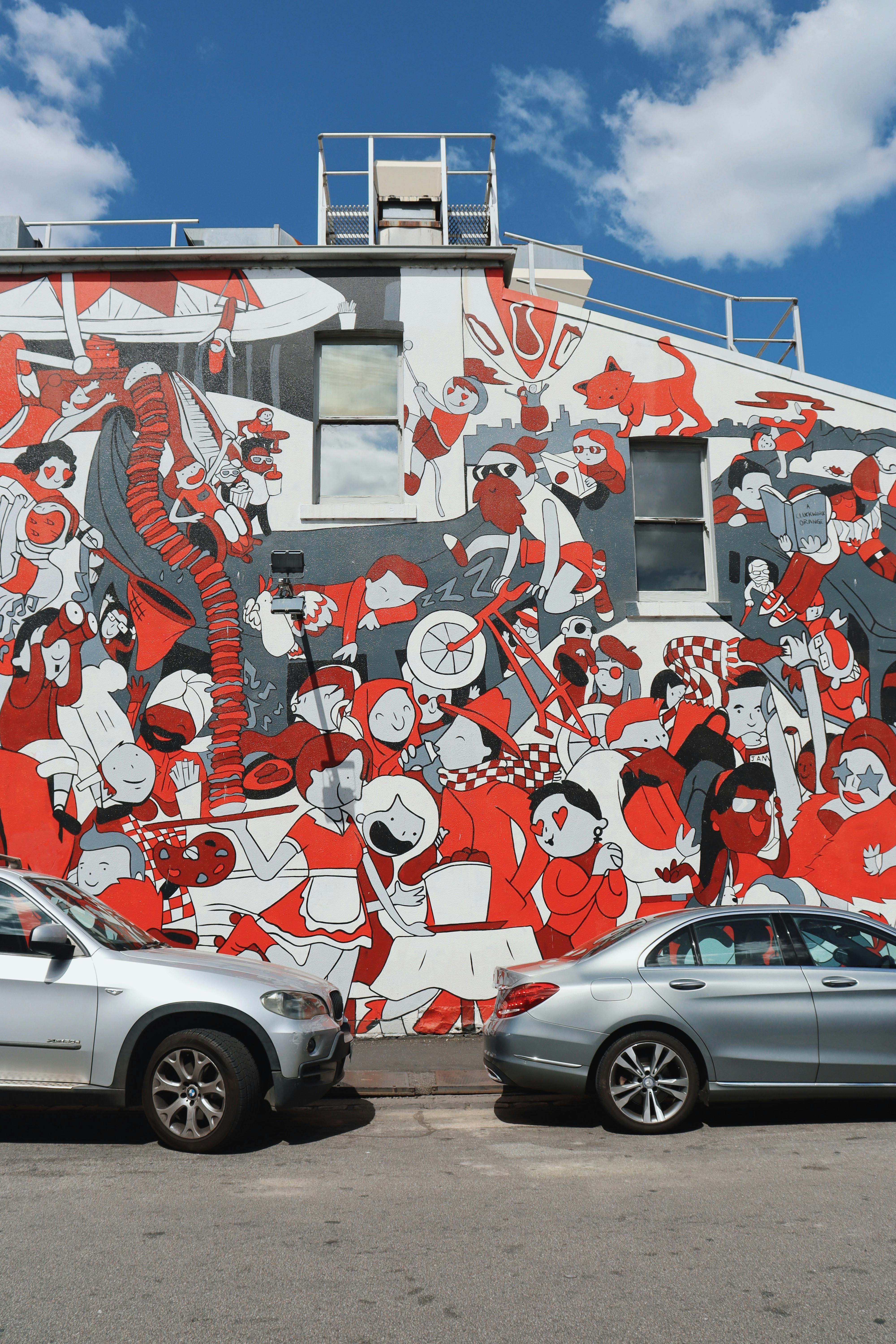 Cars Parked by Building Wall with Mural · Free Stock Photo