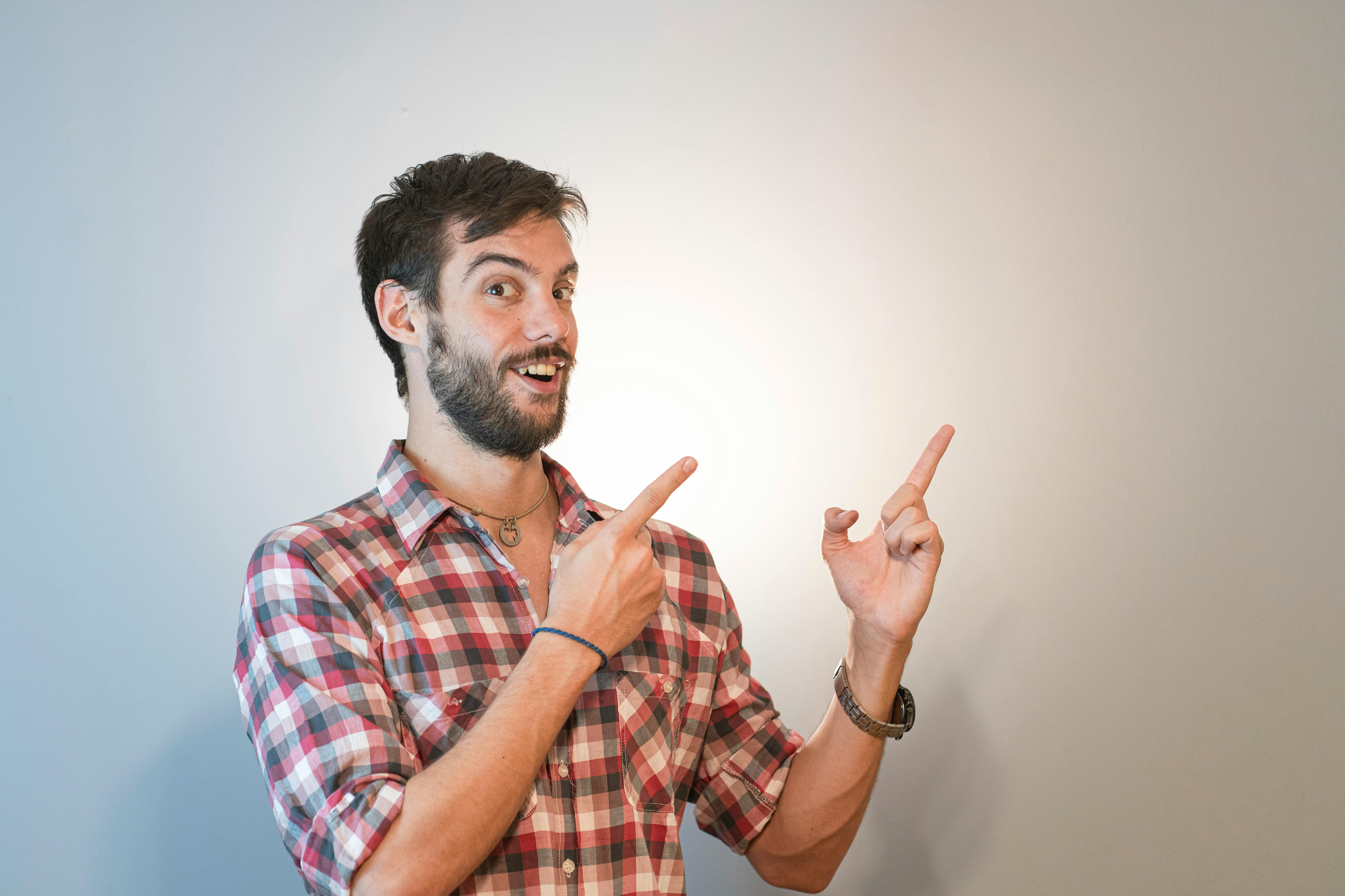 Man in a Plaid Shirt Posing for a Thumbnail · Free Stock Photo