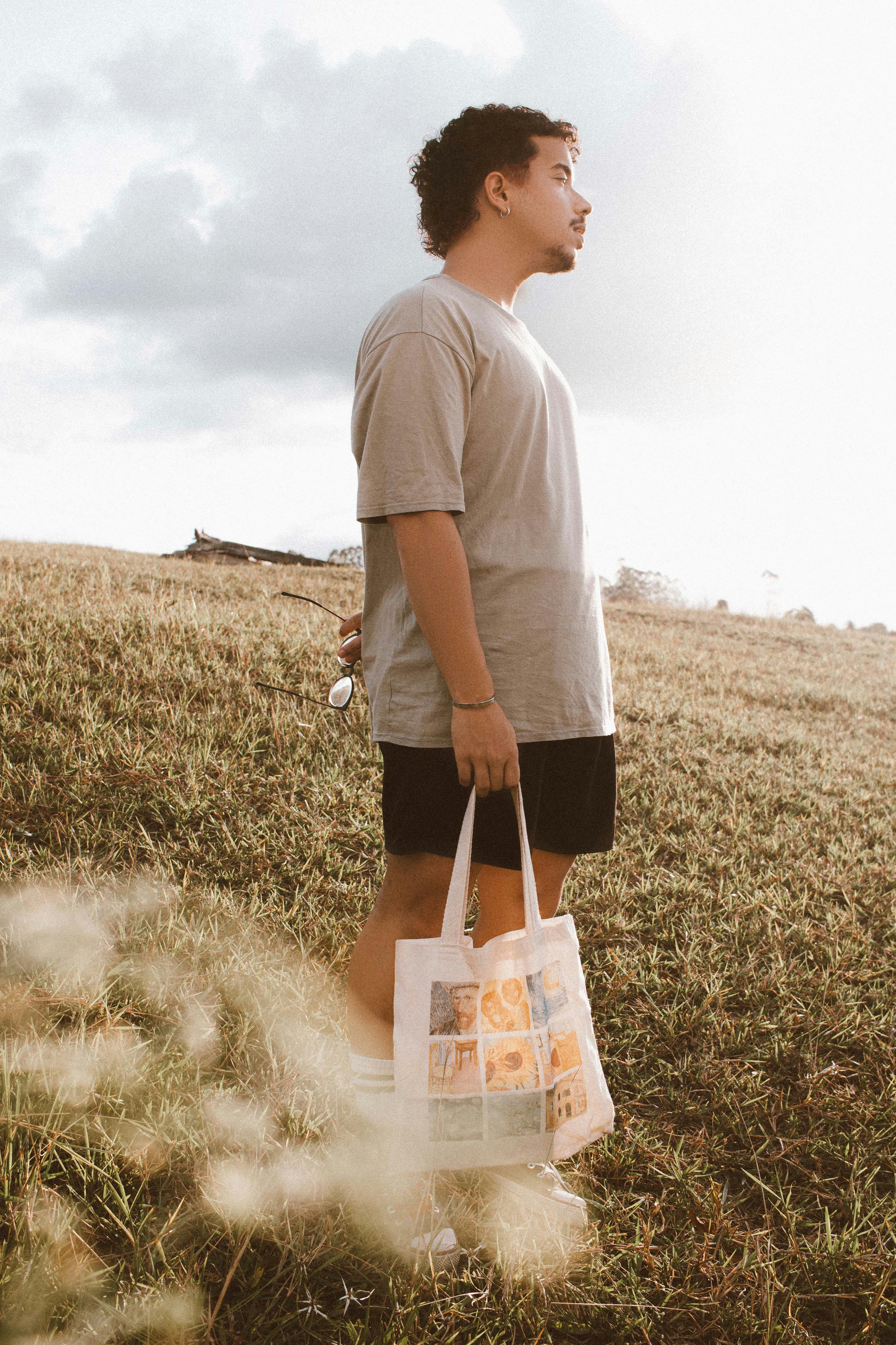 Man in T-shirt Standing with Bag · Free Stock Photo