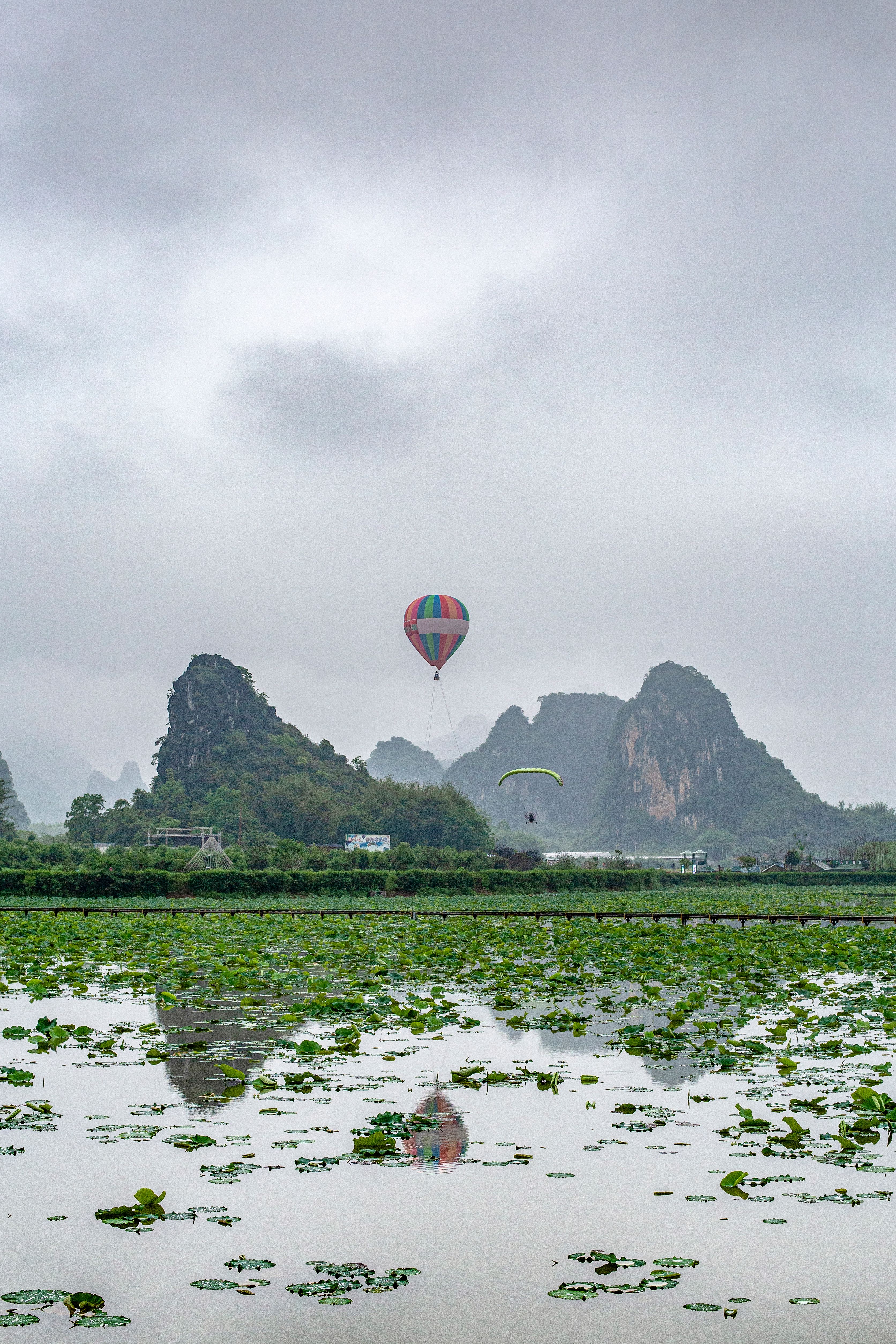 A Hot Air Balloon Flying over Rock Formations · Free Stock Photo