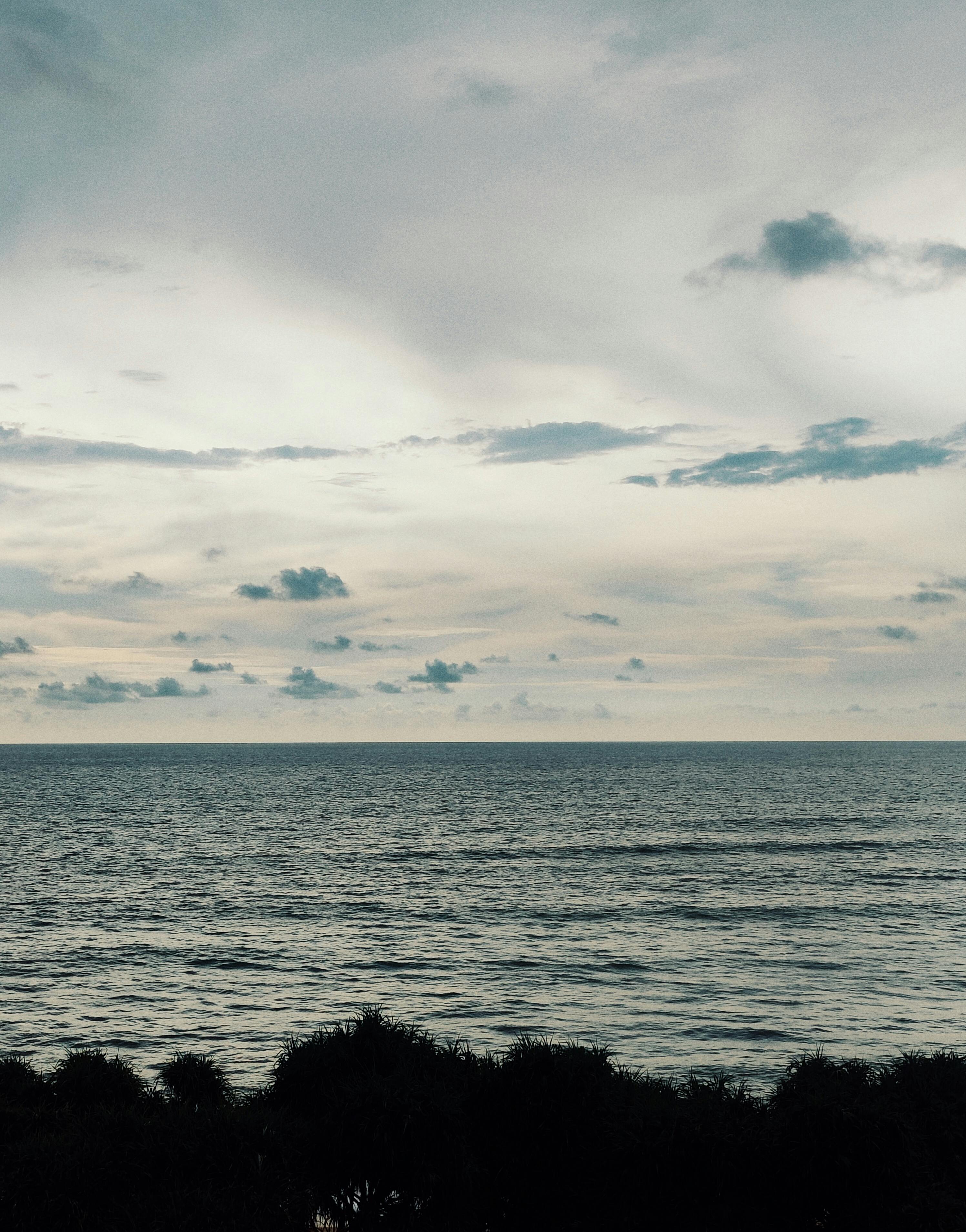 Calm Seashore on Cloudy Day · Free Stock Photo