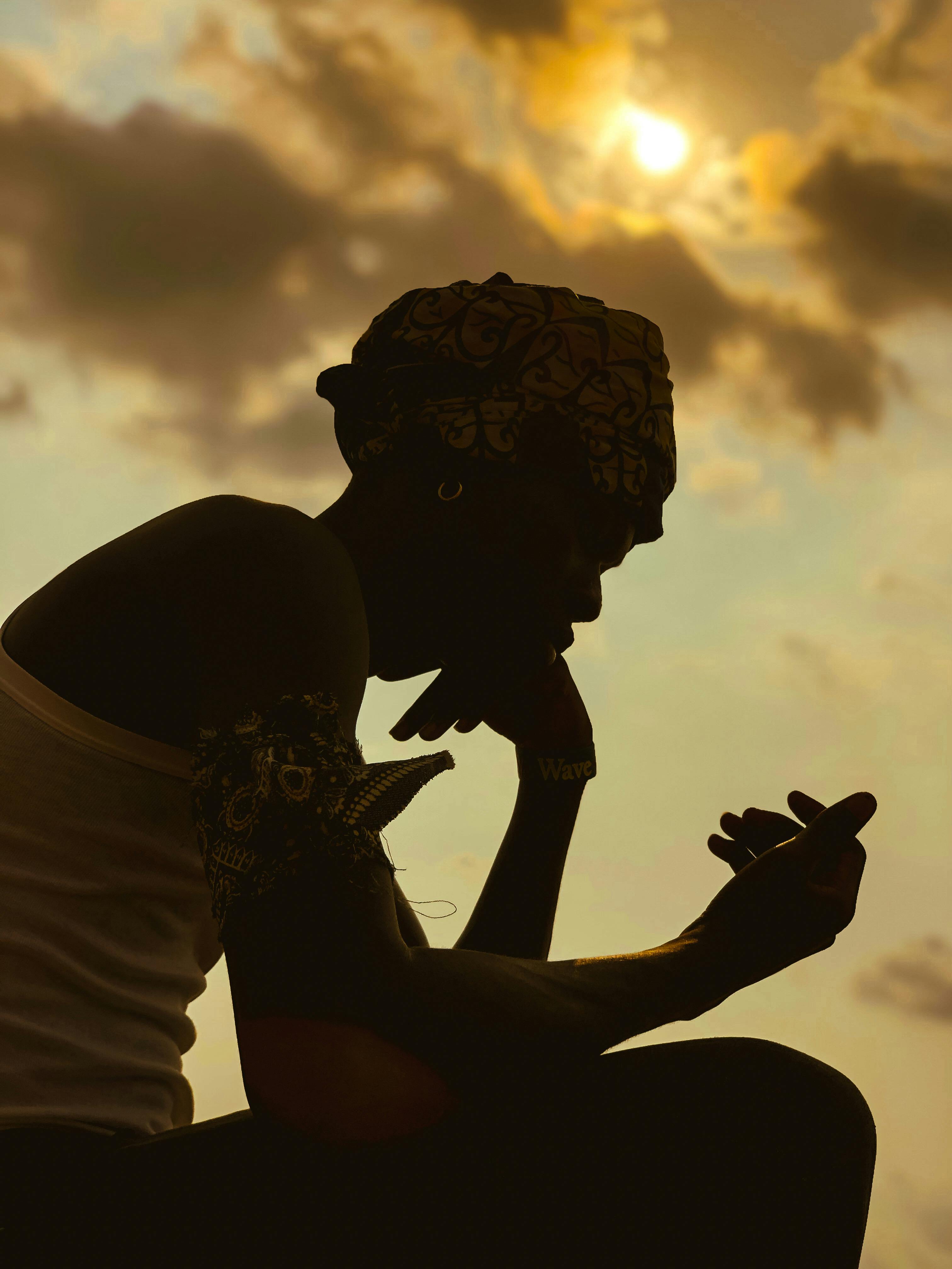 Silhouette of a Sitting Contemplative Woman · Free Stock Photo