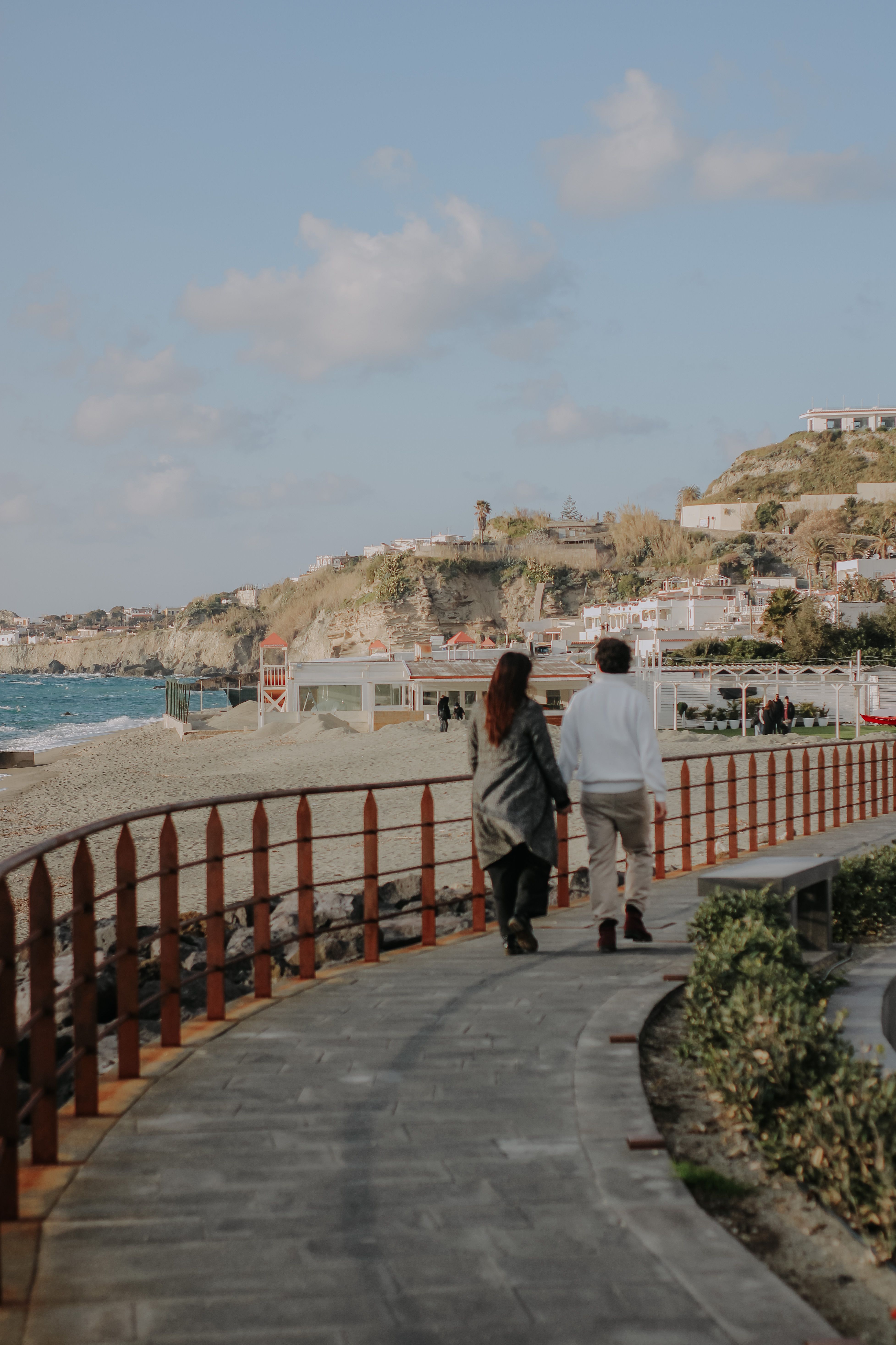 People Walking on Sidewalk along Beach · Free Stock Photo