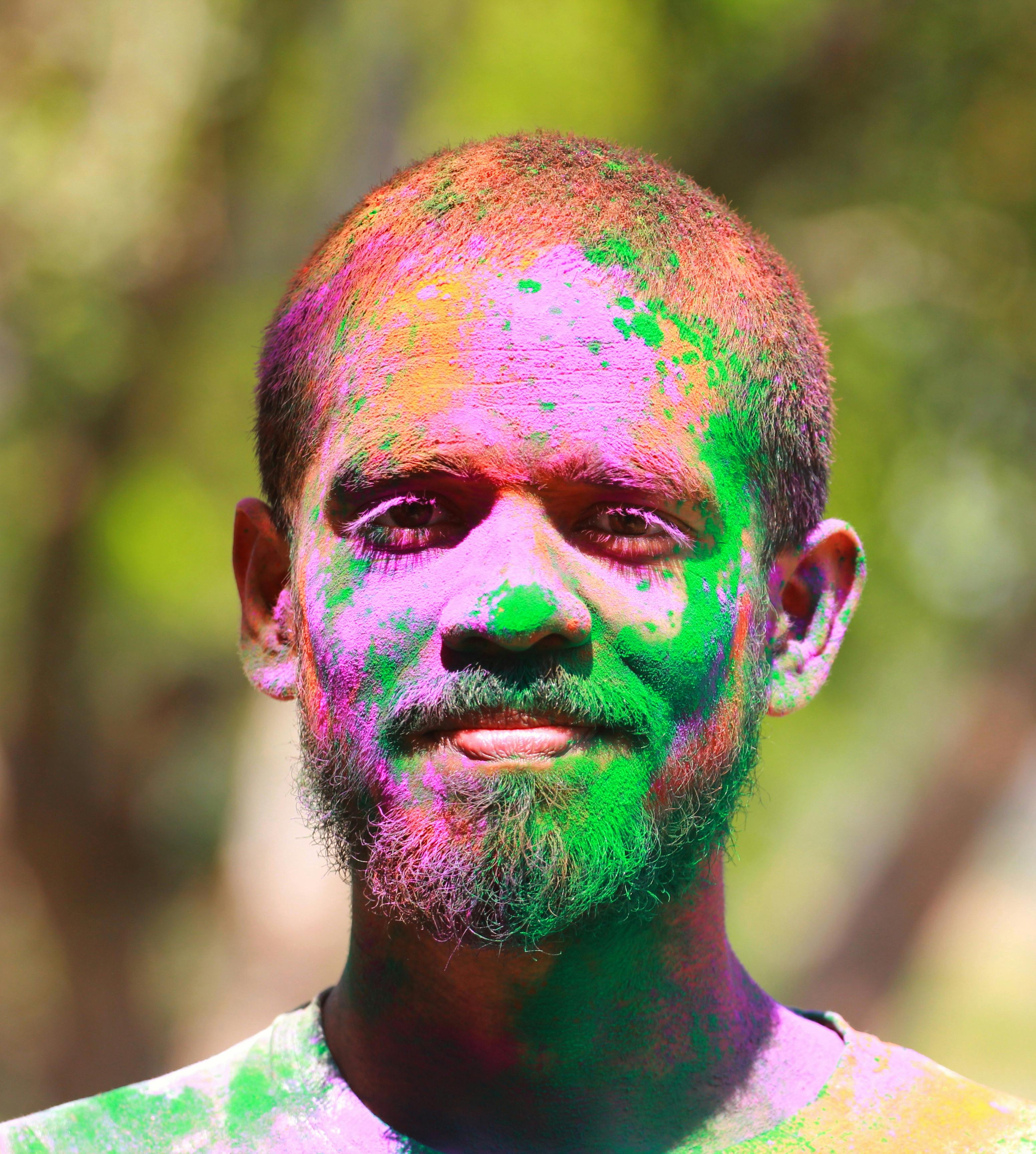 Man covered face with colorful powder paints · Free Stock Photo