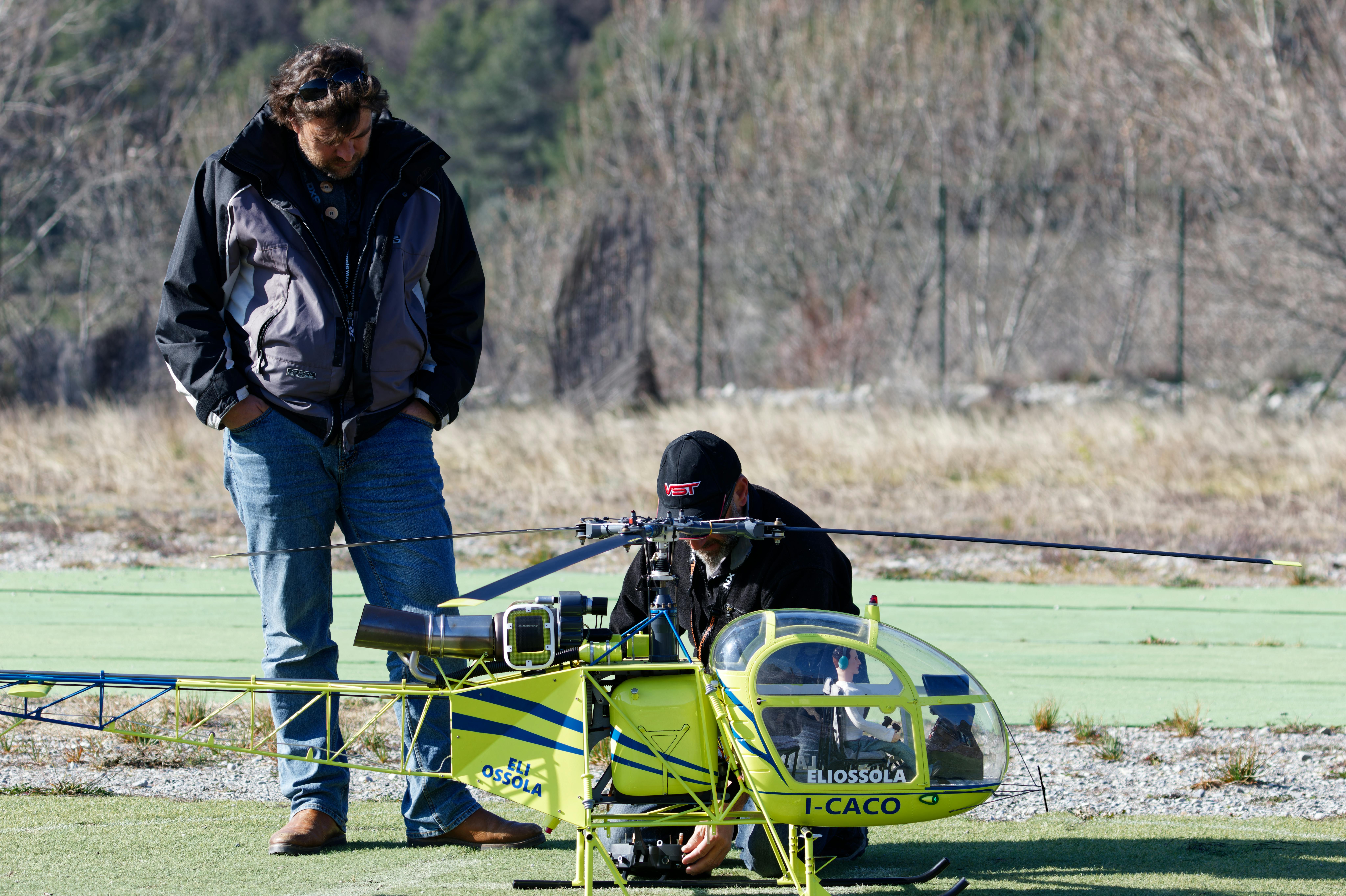 Two Men with a Drone in the Shape of a Helicopter · Free Stock Photo