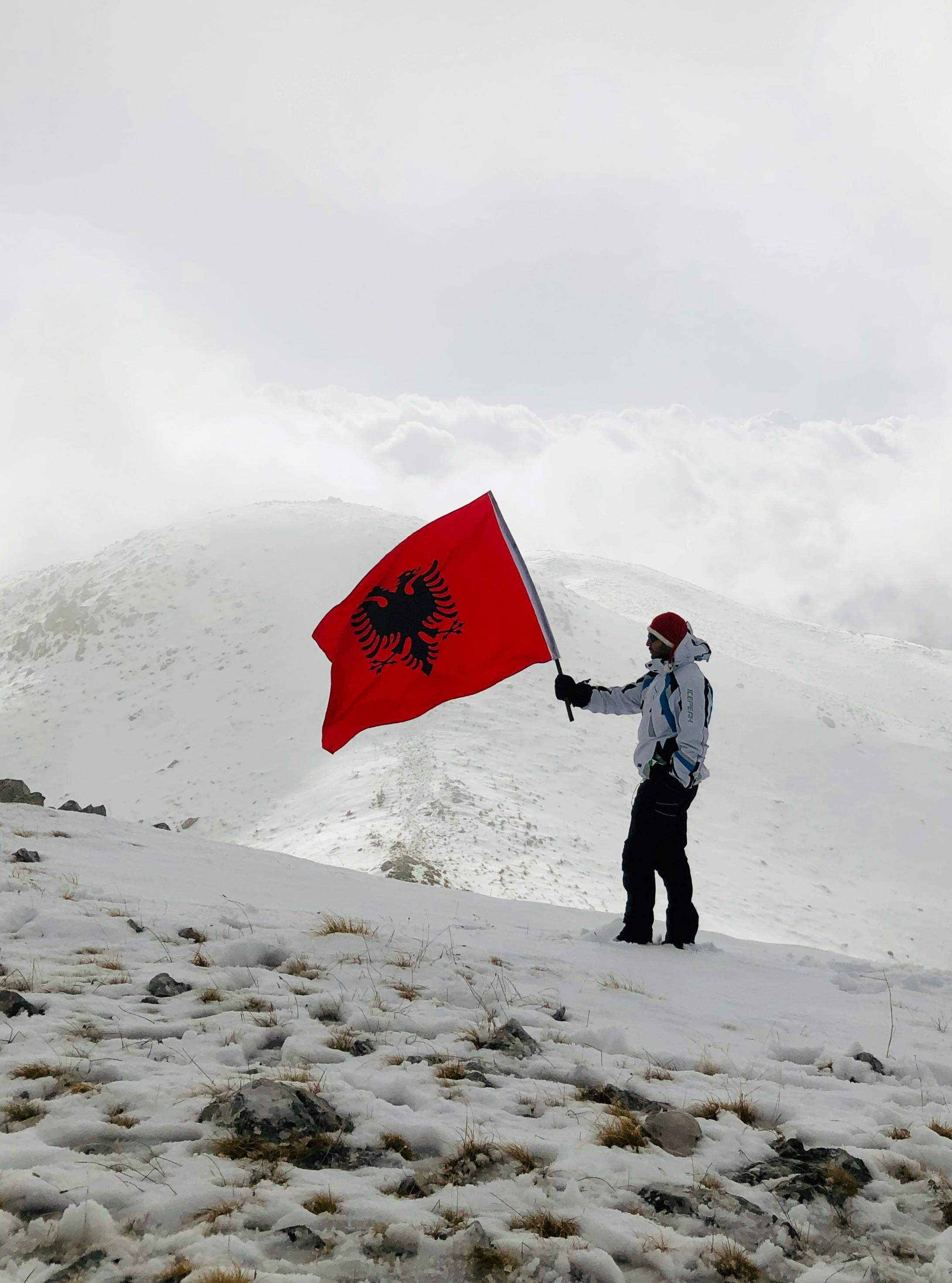 Man with Flag of Albania in Mountains · Free Stock Photo