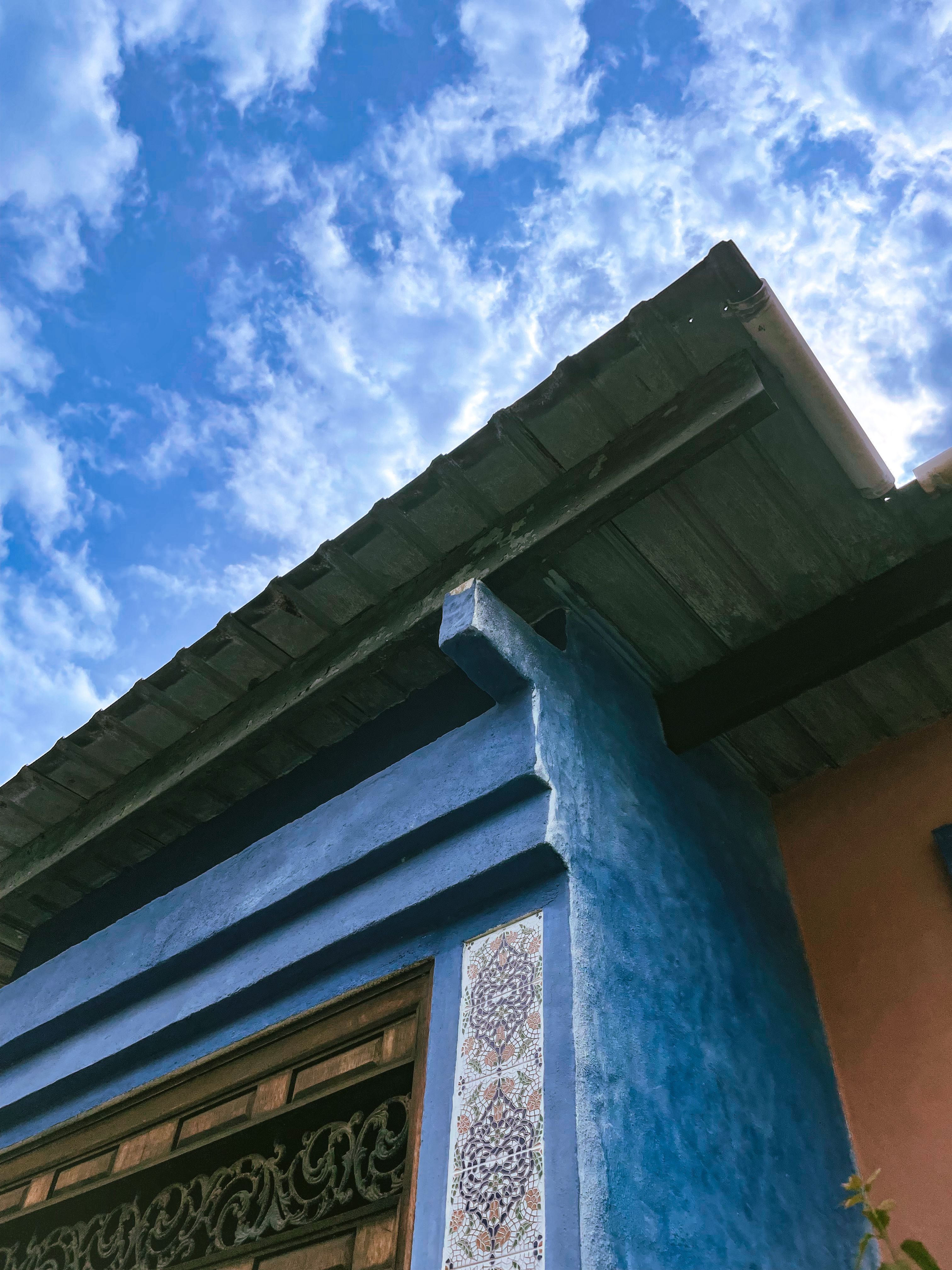 Low Angle Shot of a Roof of a Blue Traditional Building · Free Stock Photo