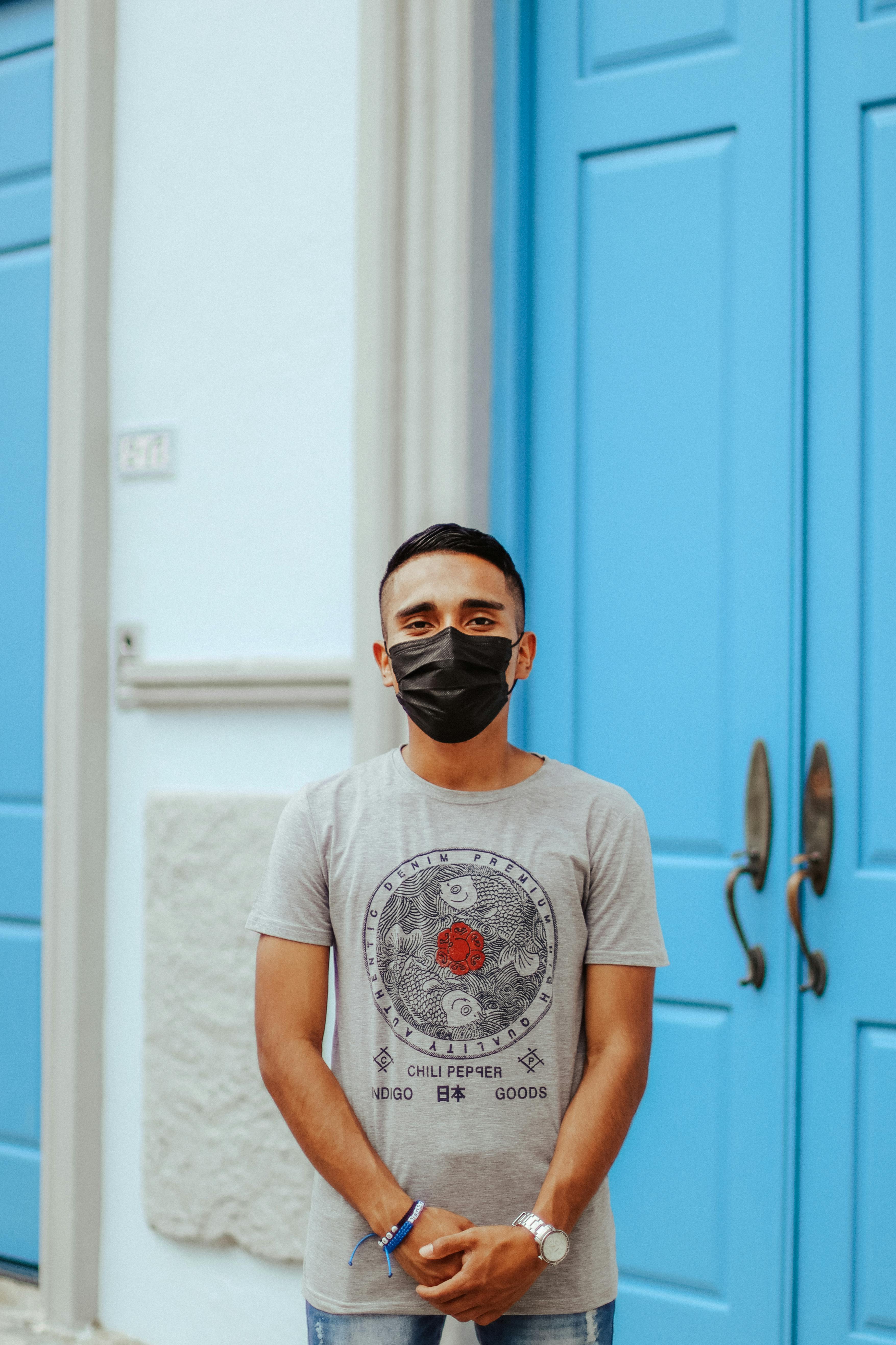 Man Standing in a Black Medial Mask · Free Stock Photo