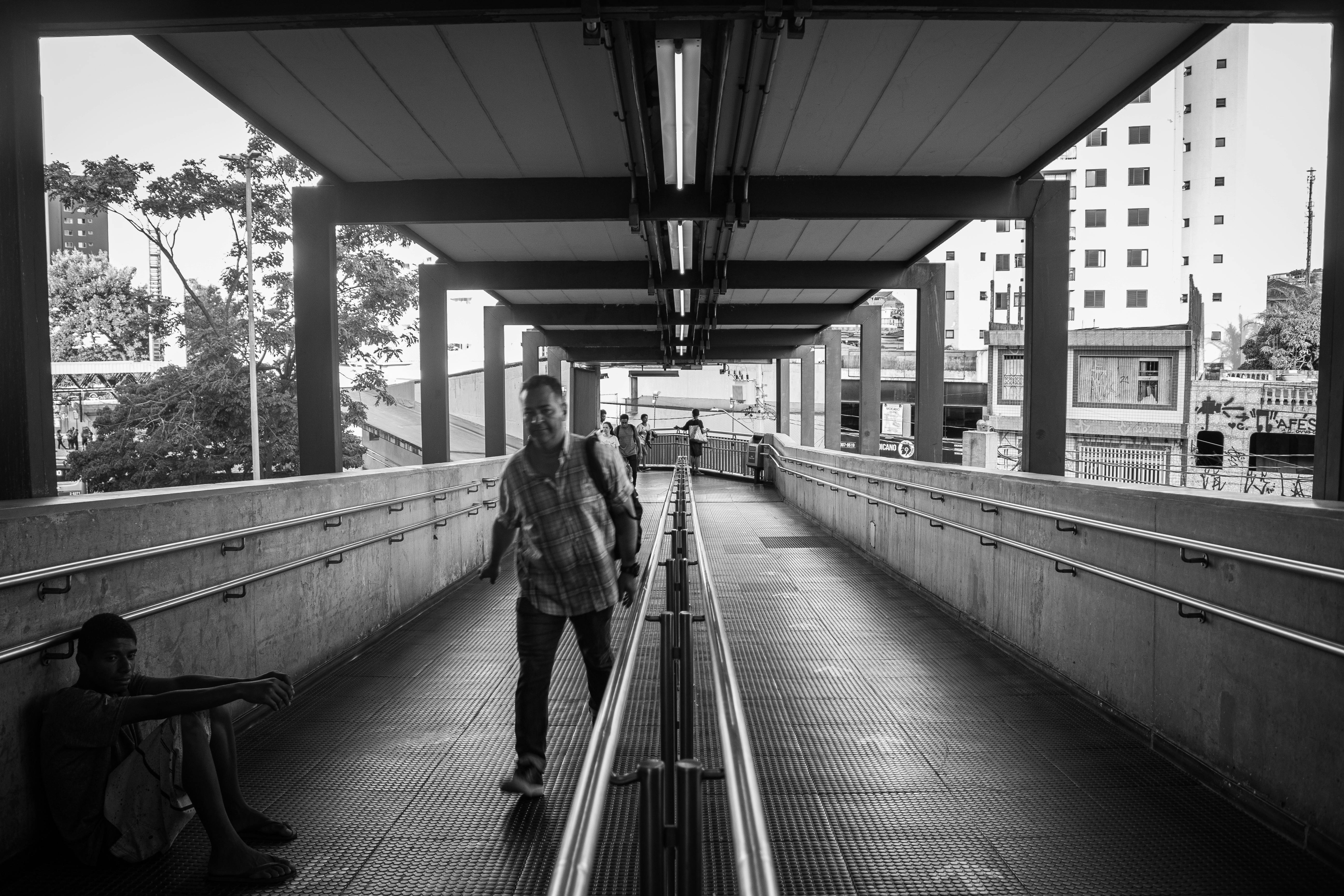 Man Walking on Pedestrian Bridge · Free Stock Photo