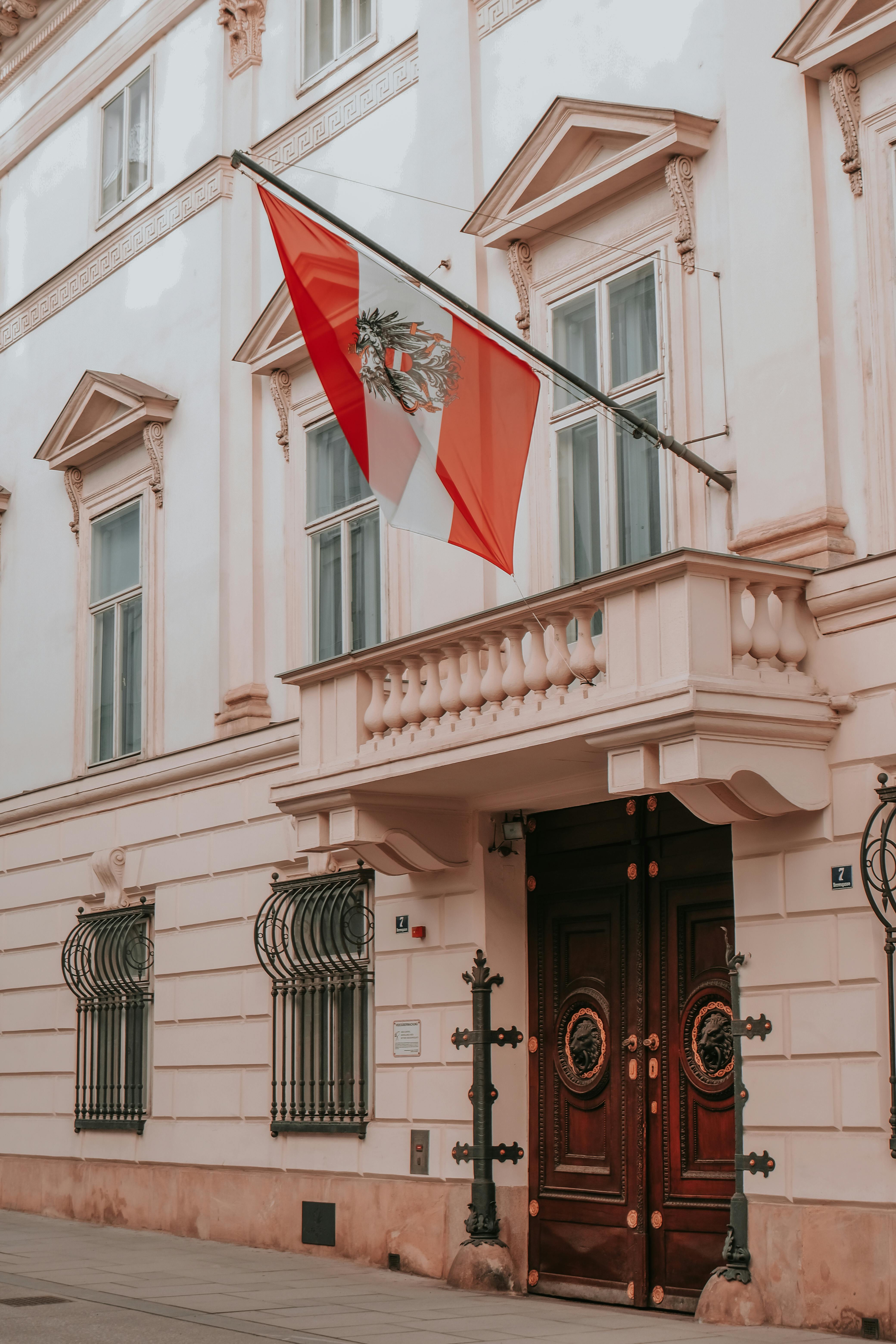 A flag flying outside of a building · Free Stock Photo