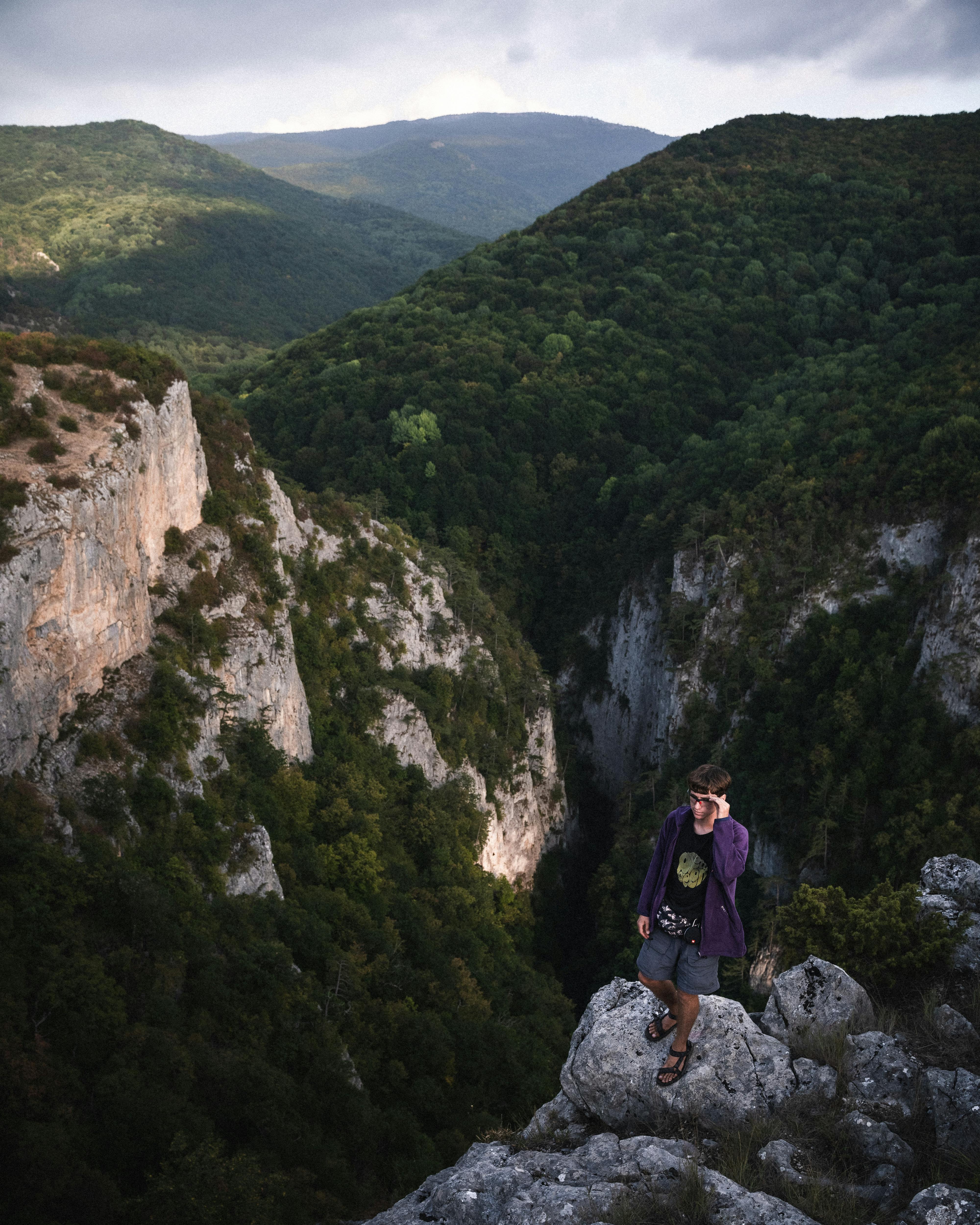 High Angle Shot of a Young Man Standing on the Edge of a Cliff · Free ...