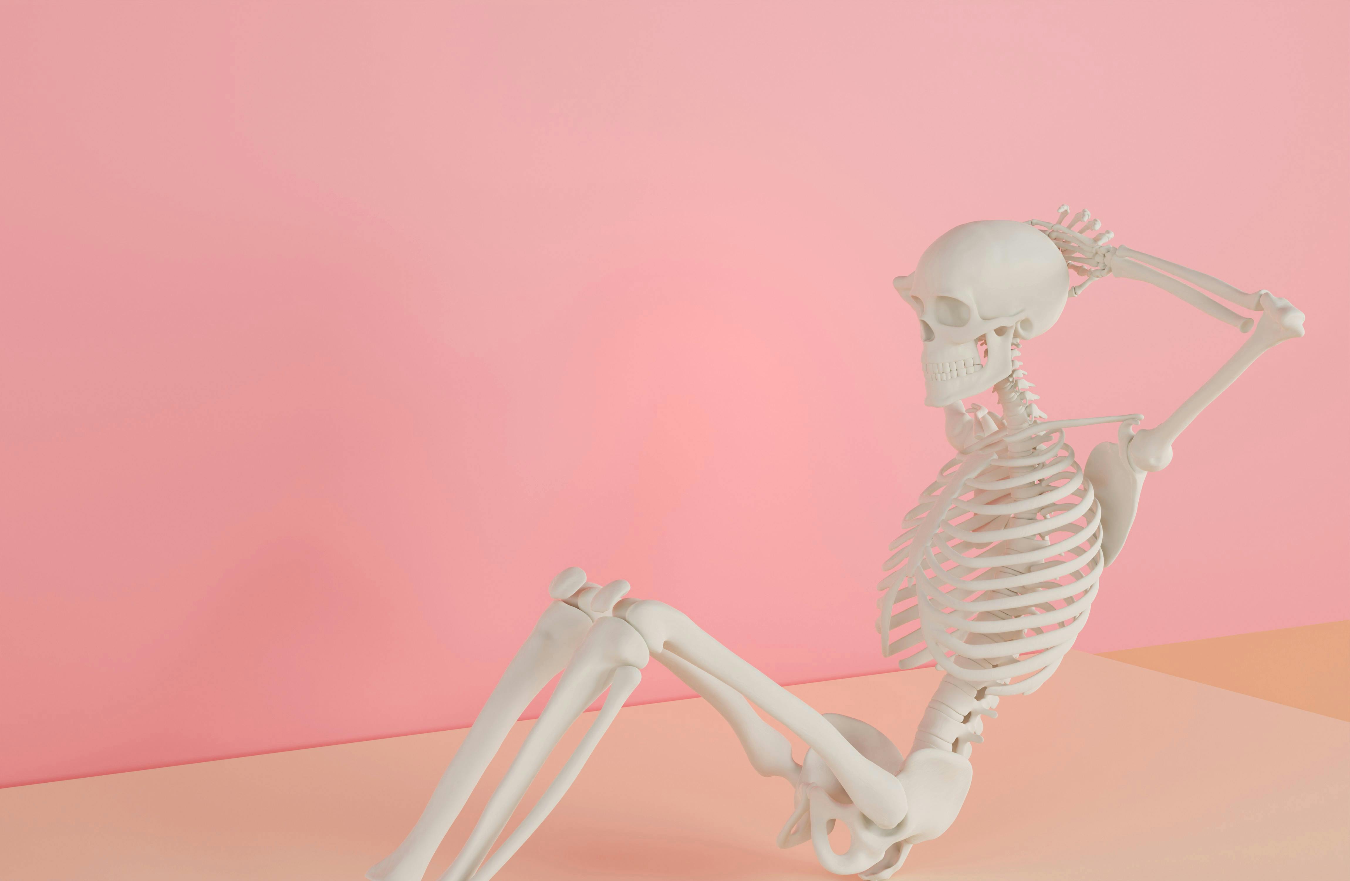 Person Skeleton Stretching in Pink Studio · Free Stock Photo