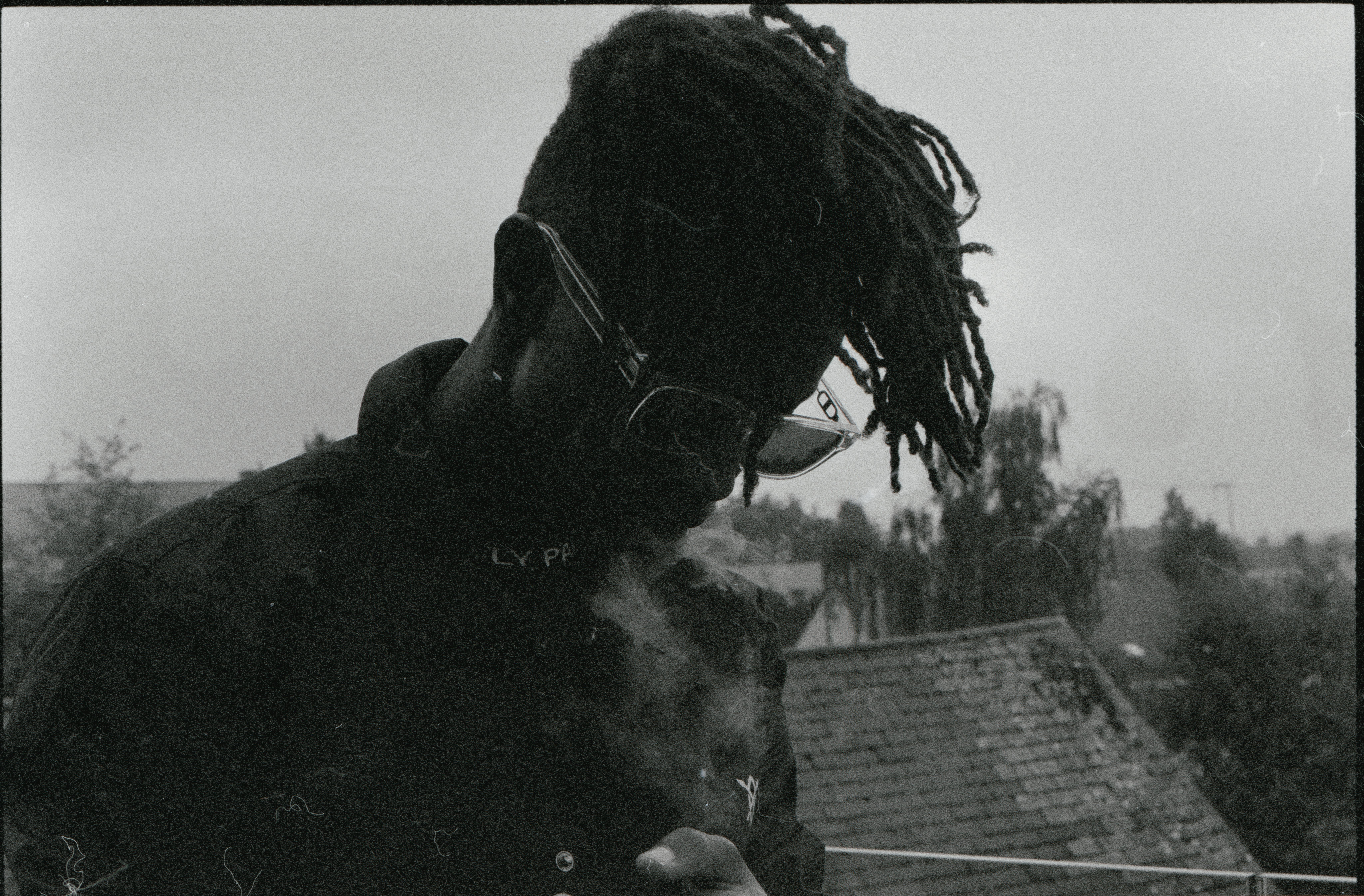 Black and White Picture of a Man with Dreadlocks Smoking · Free Stock Photo