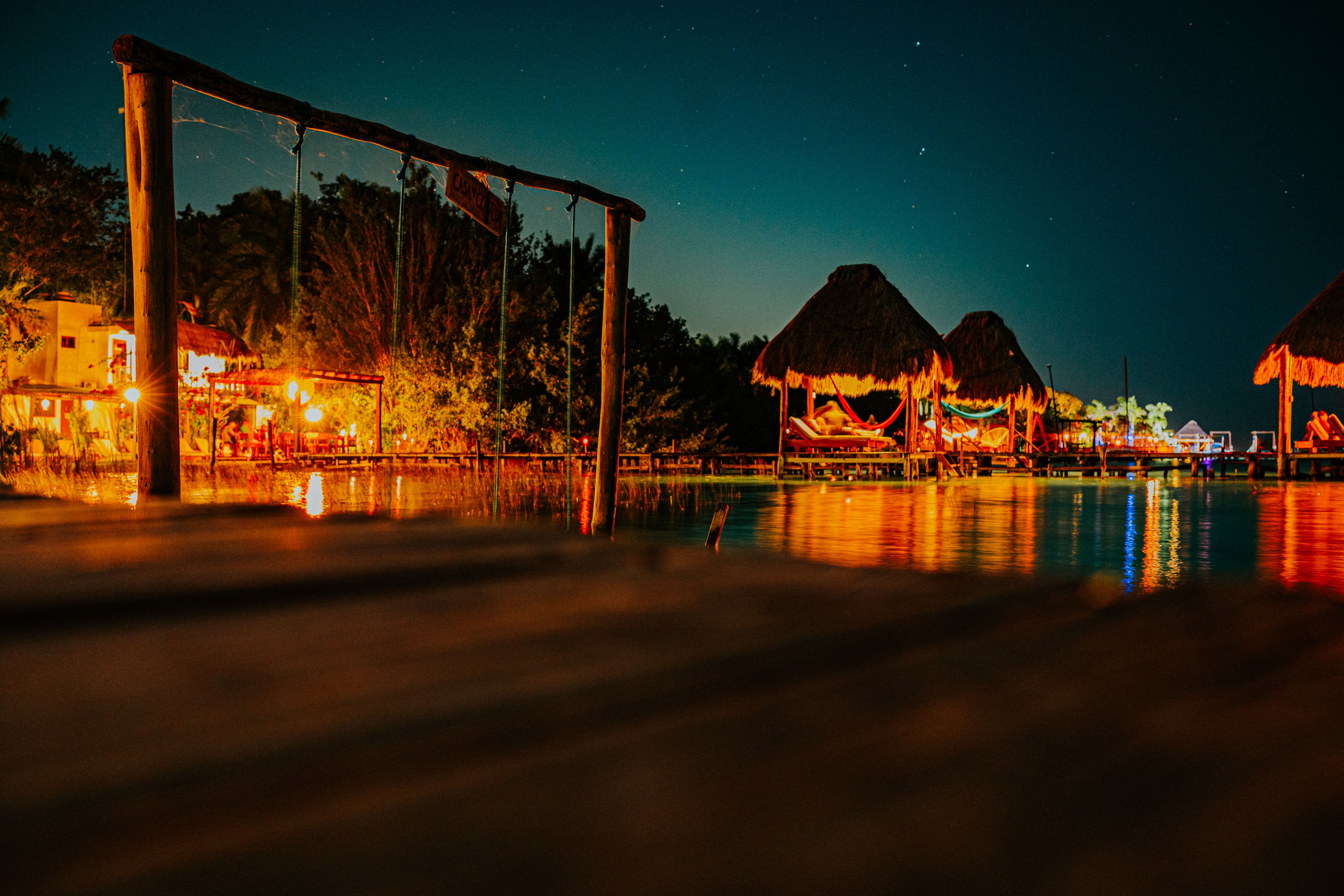 A pier at night with a dock and a hut · Free Stock Photo