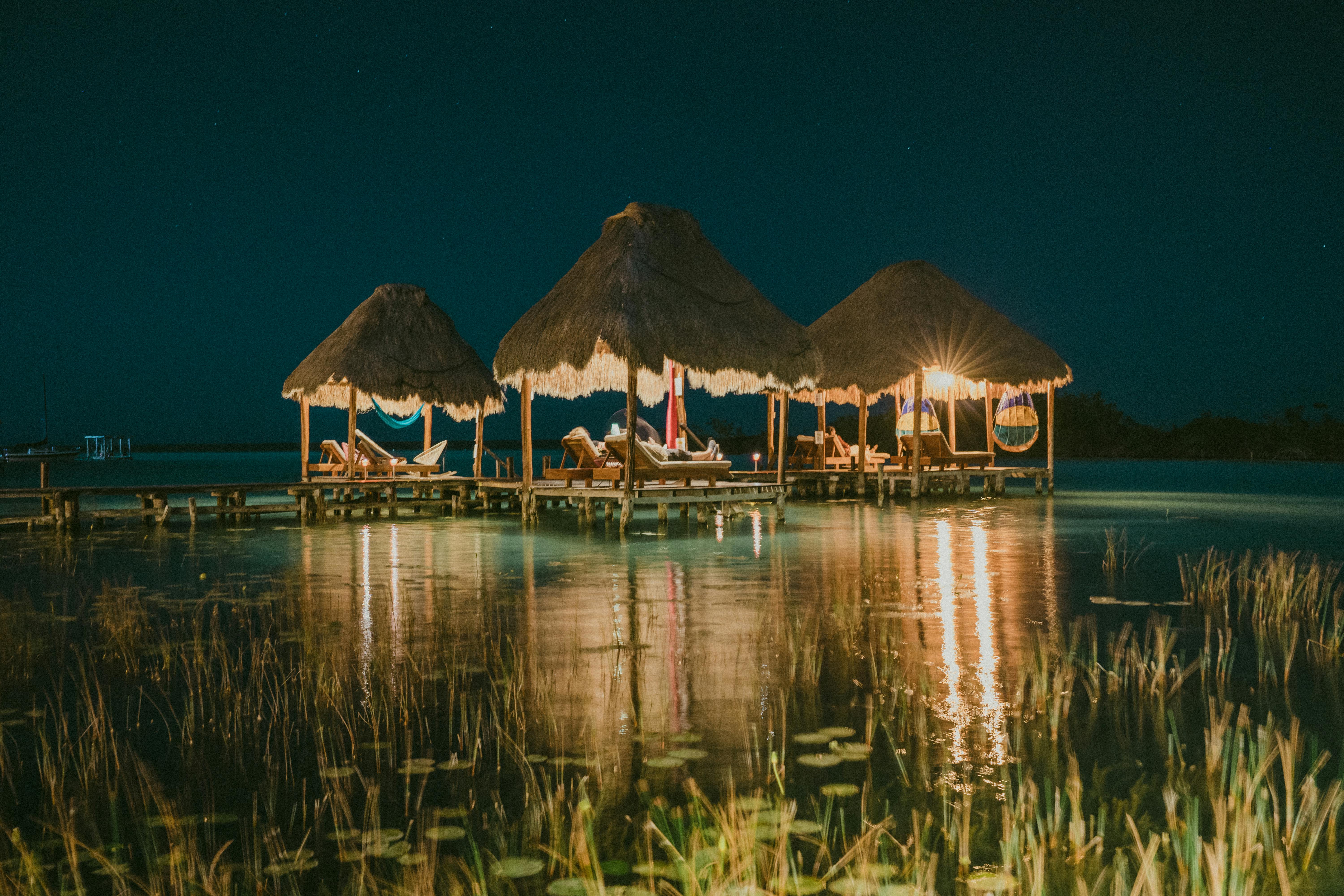 Illuminated Gazebos in Water at Night · Free Stock Photo