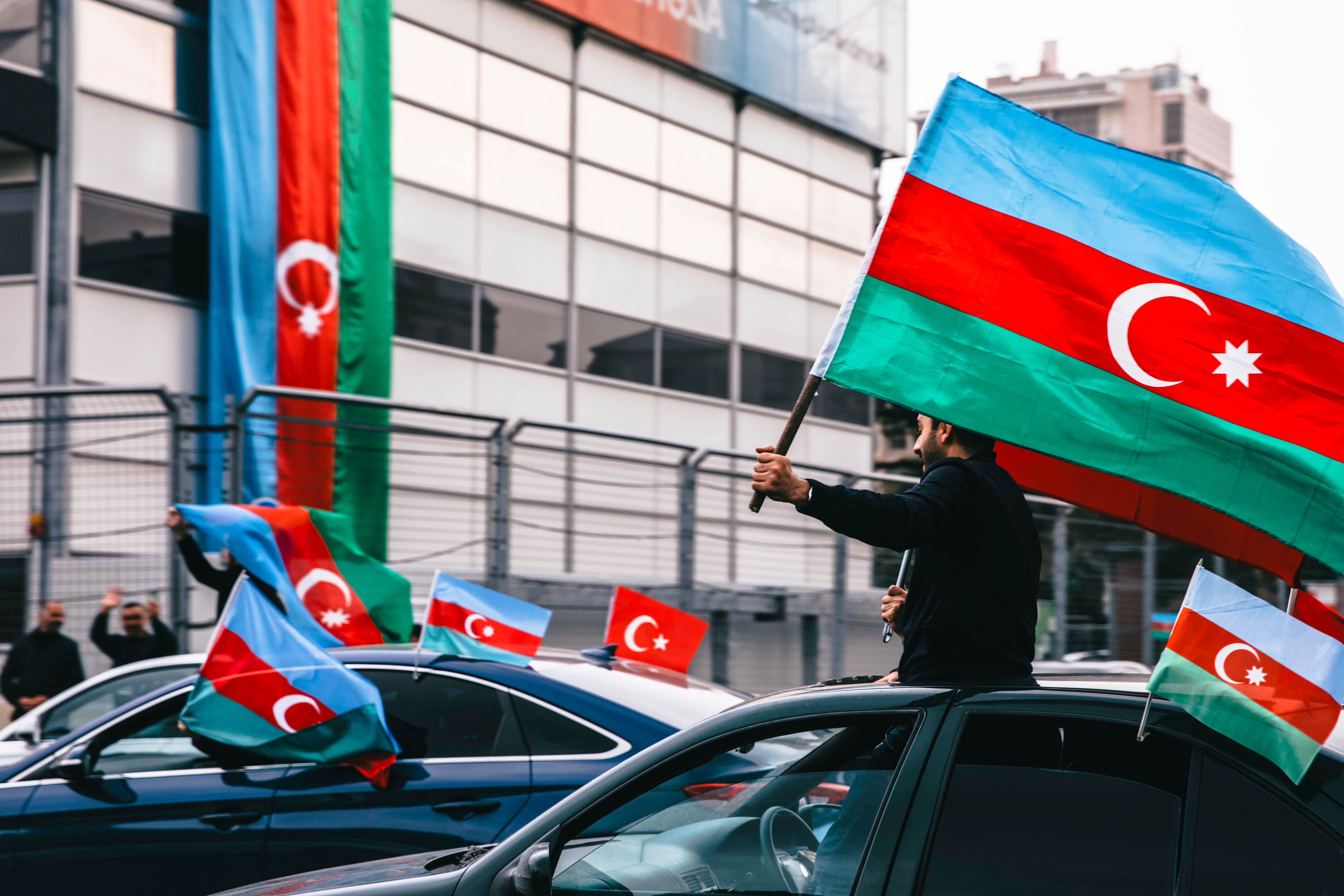 Man Wearing a Face Mask and Holding Flags at a Protest · Free Stock Photo