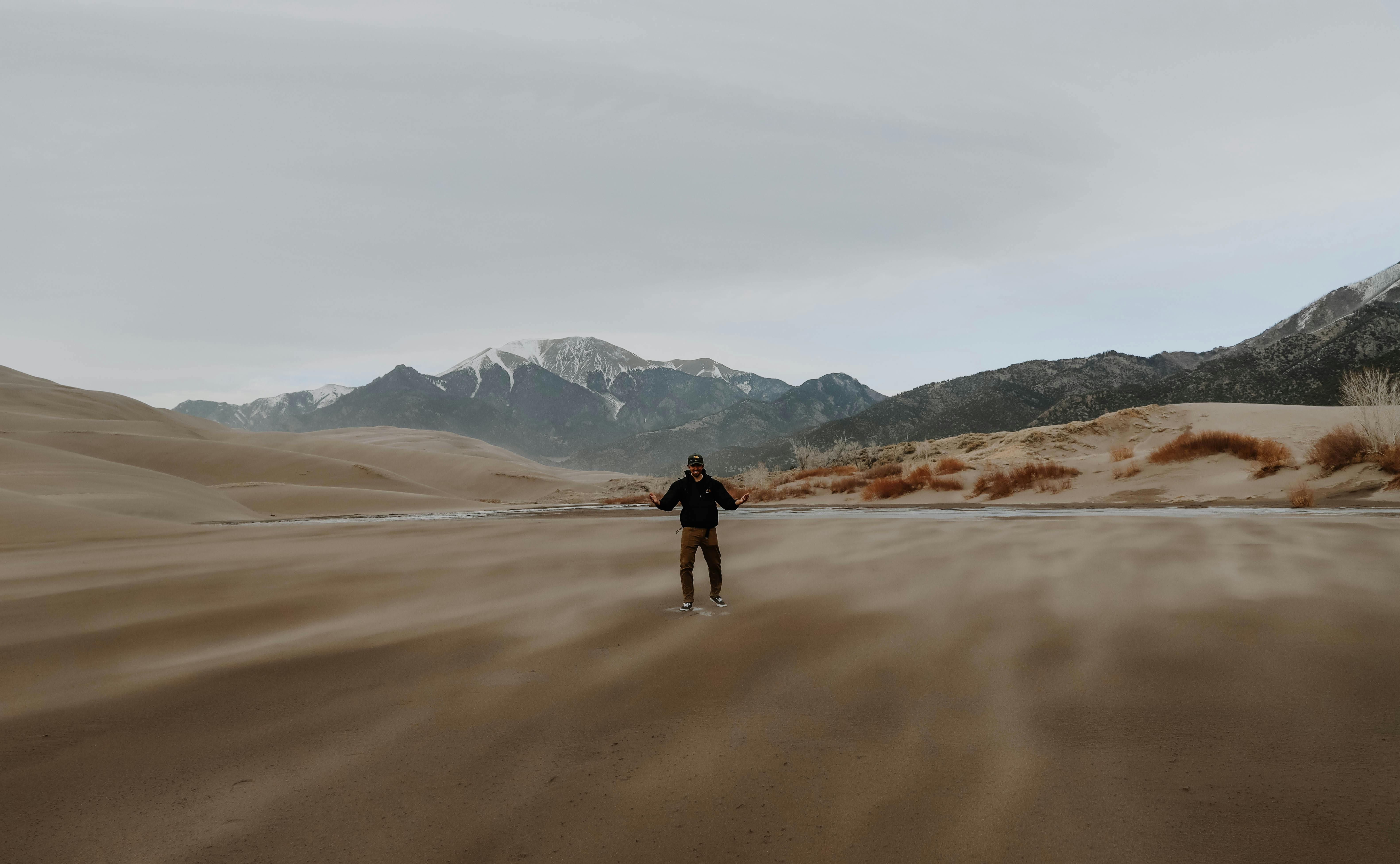 Man on a Desert Among Mountains · Free Stock Photo