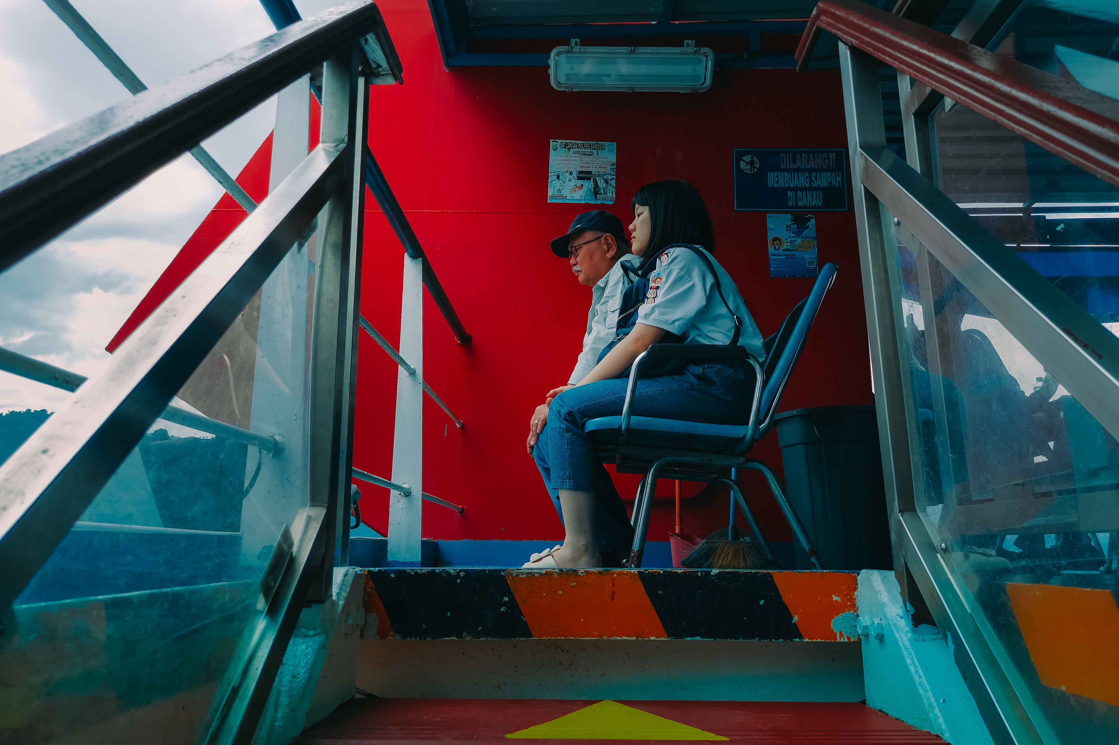 Woman and Man Sitting on Chairs behind Stairs · Free Stock Photo