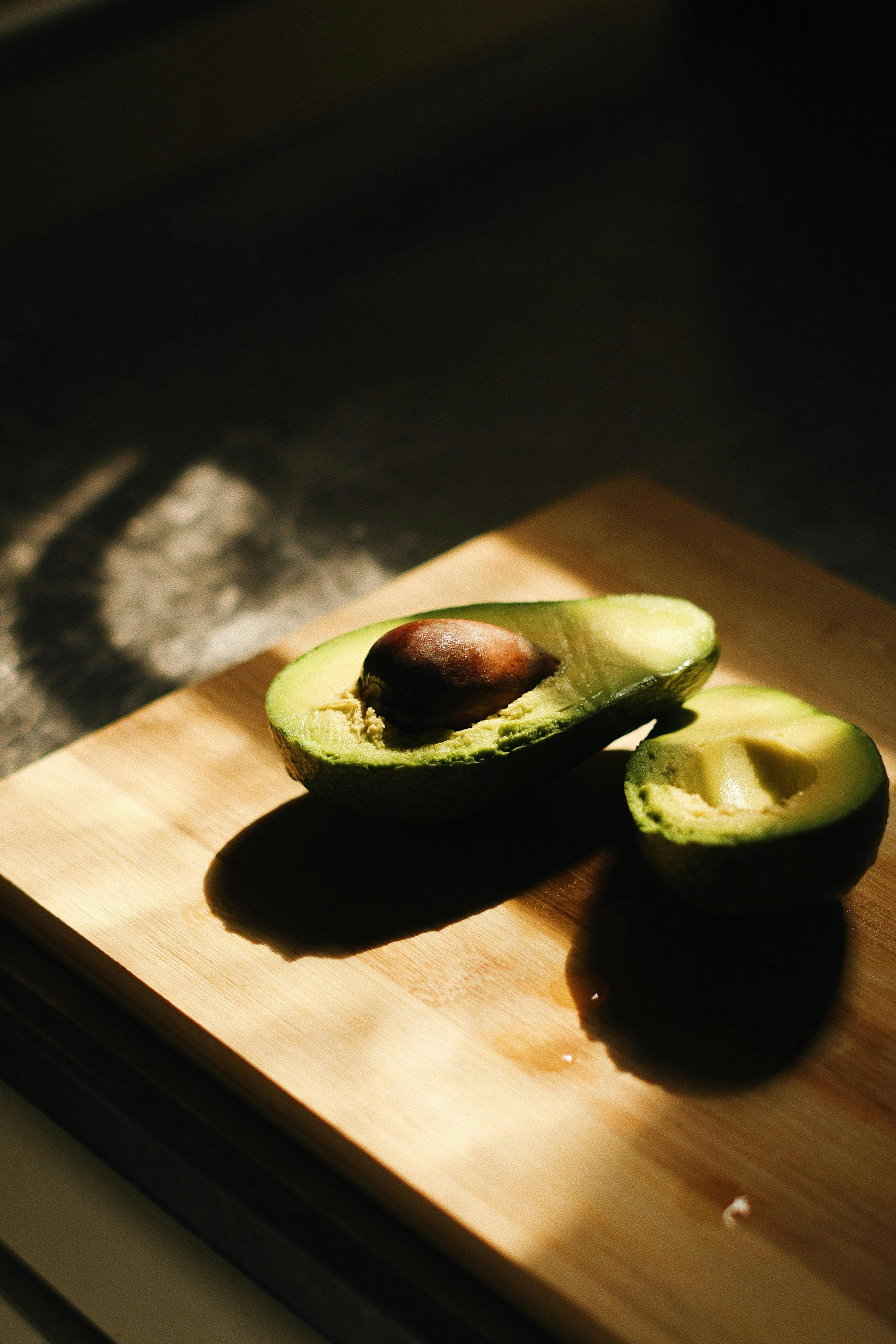 Two avocados on a cutting board · Free Stock Photo