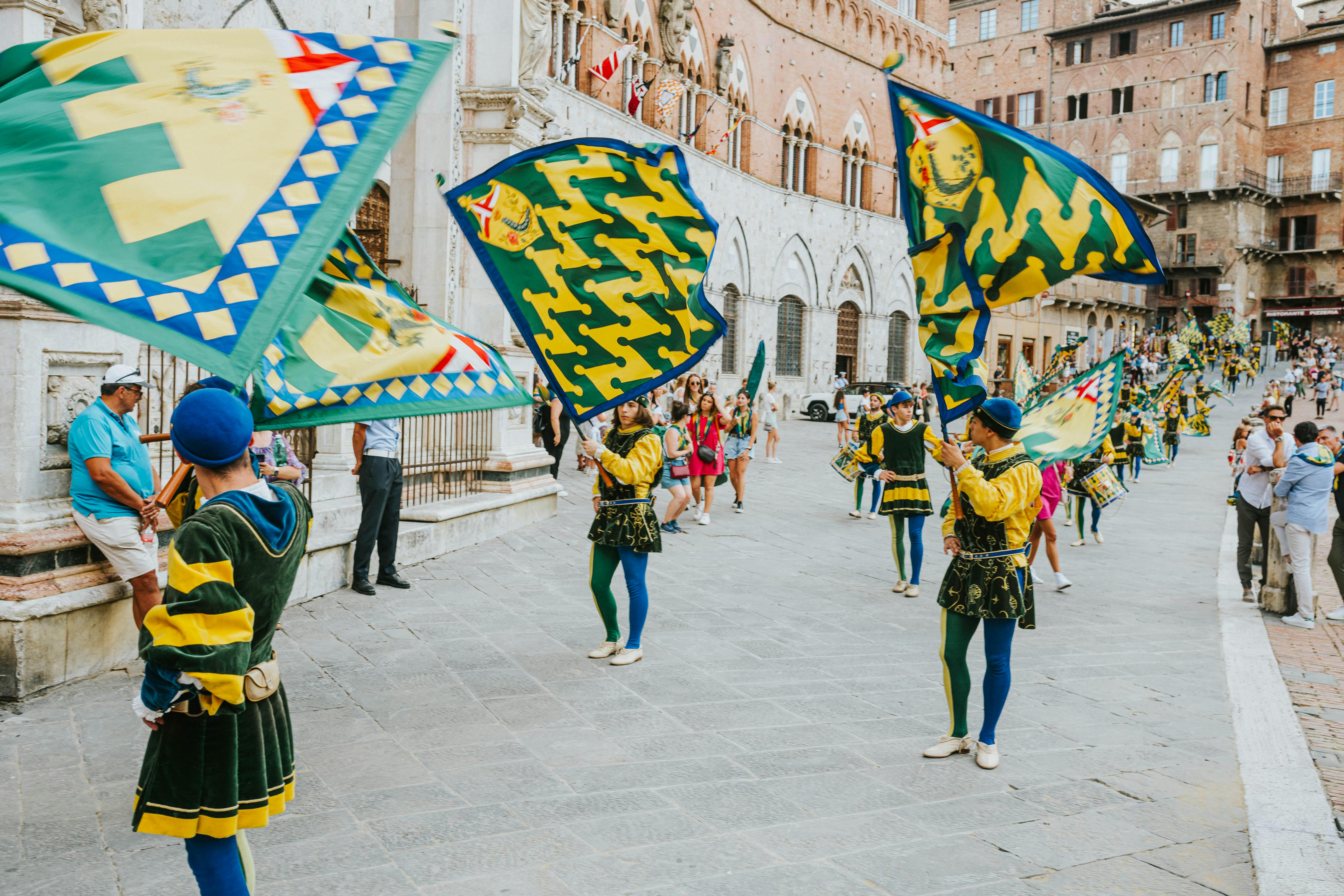 People in Costumes with Flags at Parade · Free Stock Photo