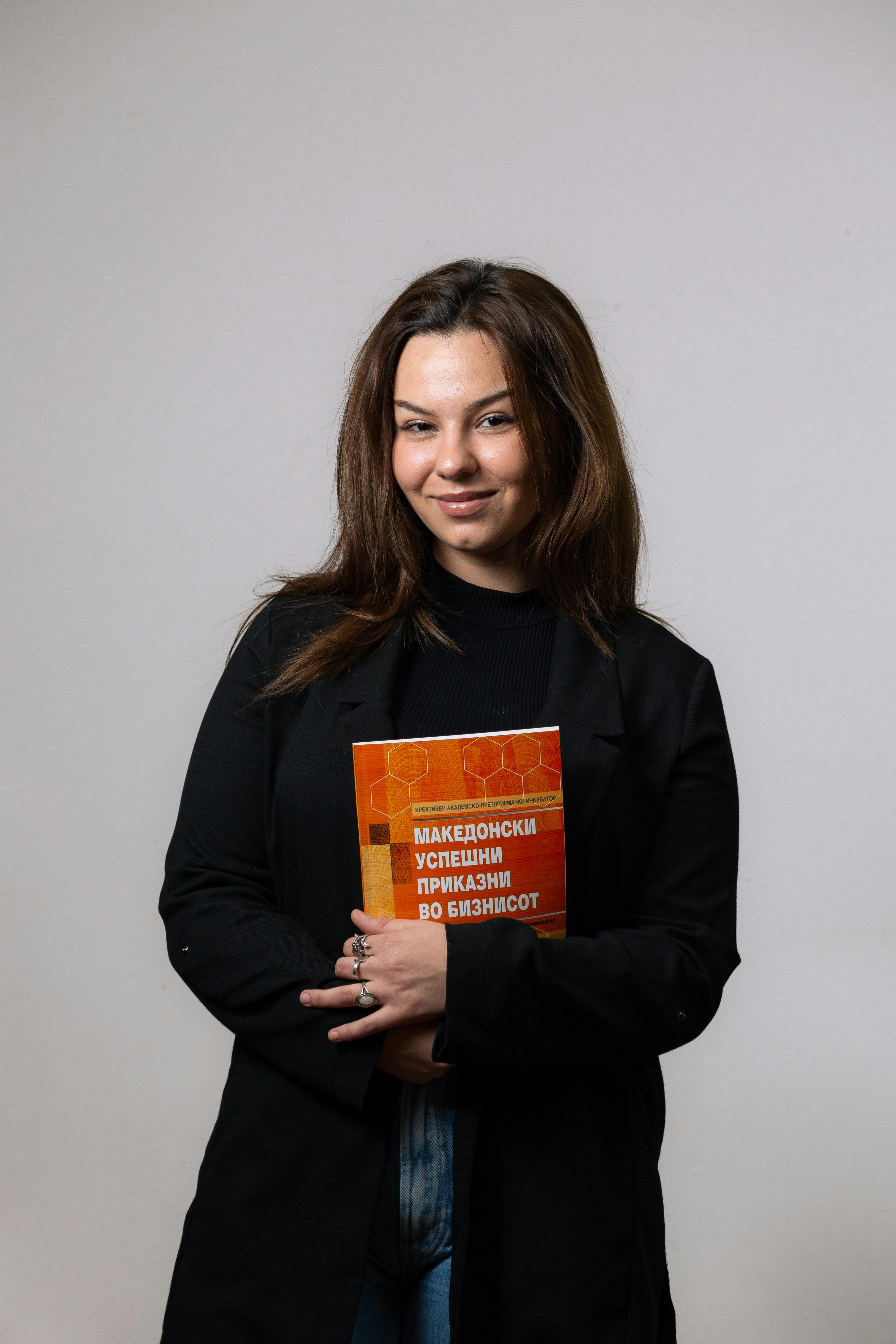 Young Student Holding a Textbook · Free Stock Photo