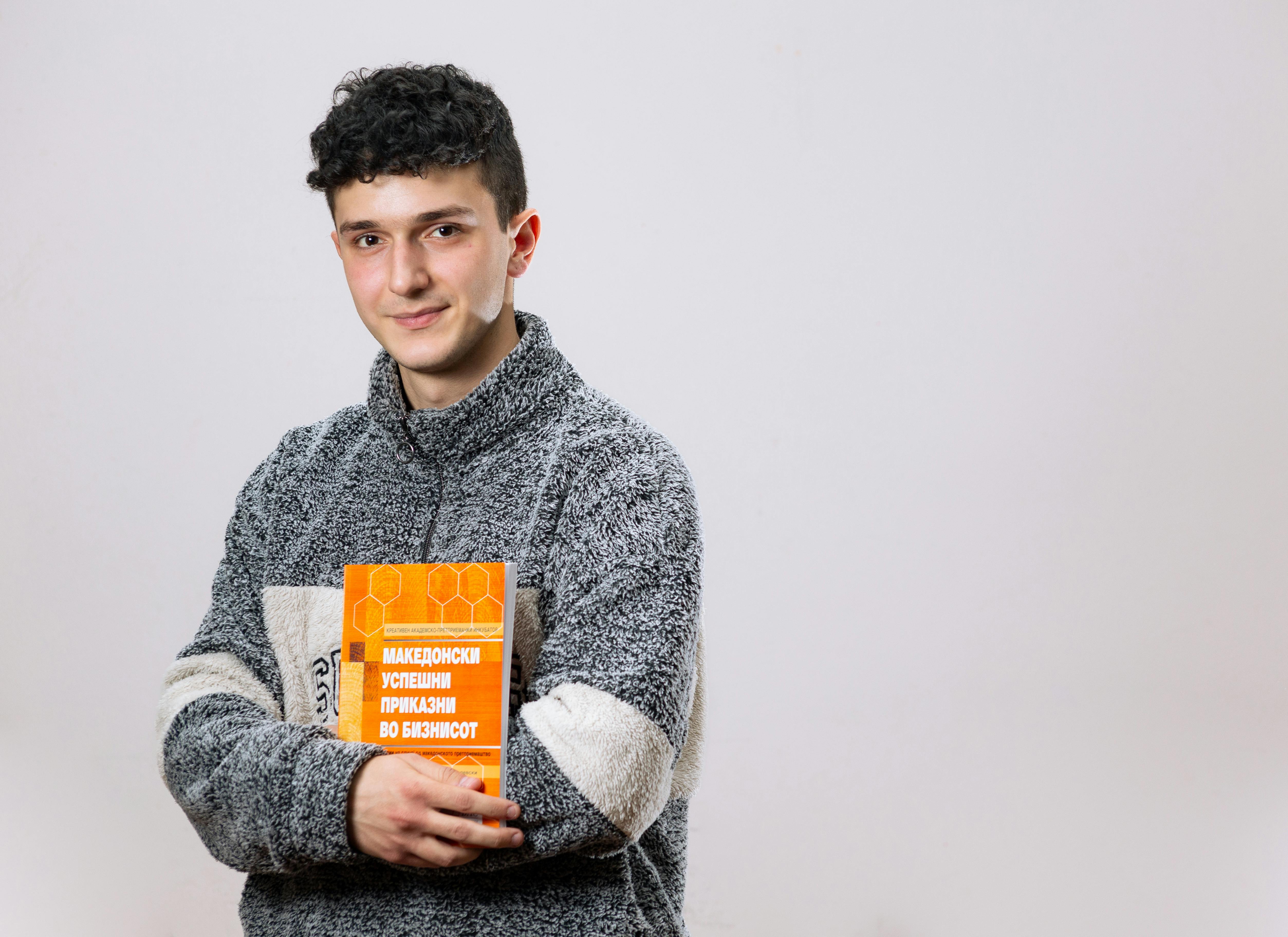 Young Man Holding a Textbook · Free Stock Photo