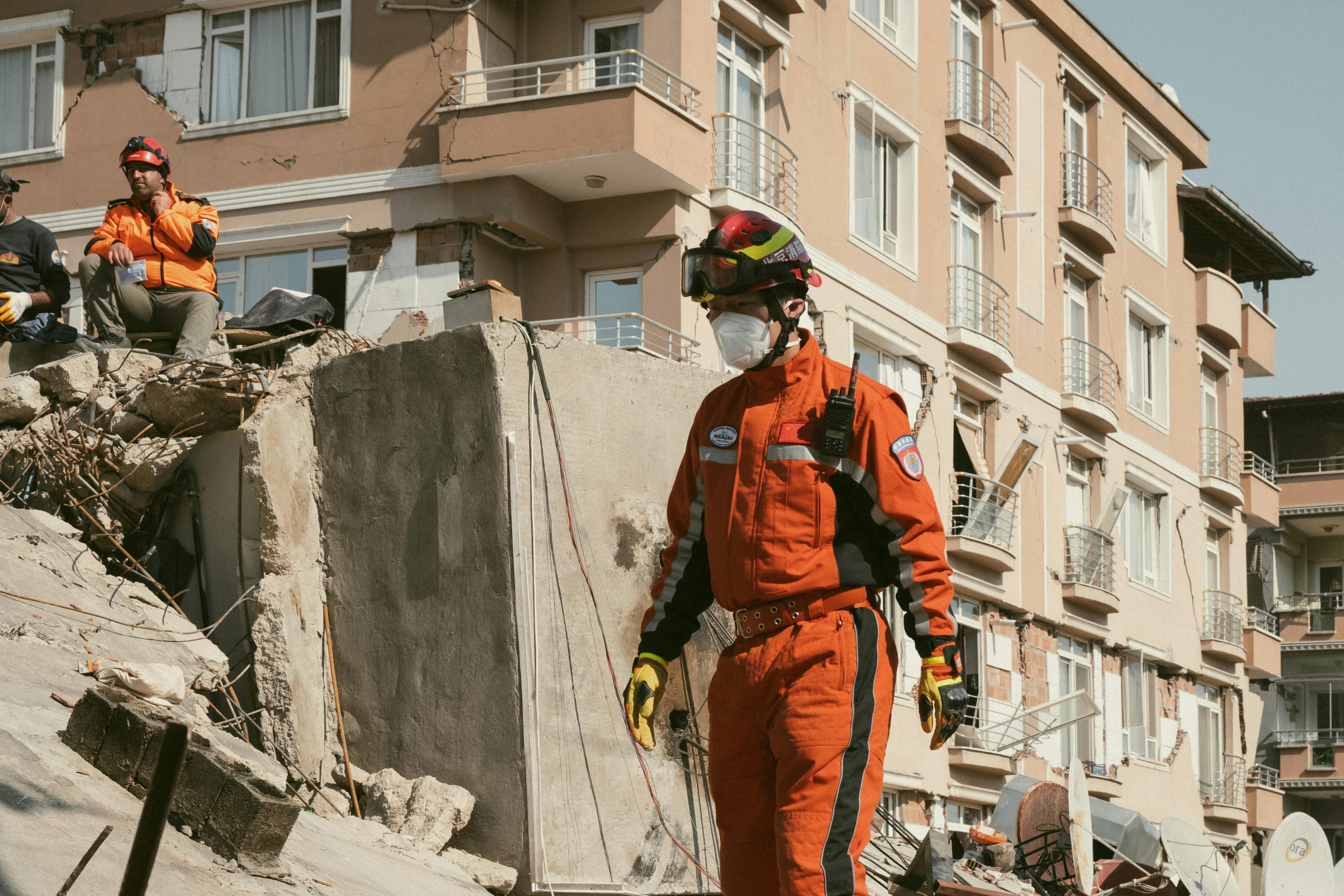 Firefighters Among Destroyed Buildings After Earthquake · Free Stock Photo