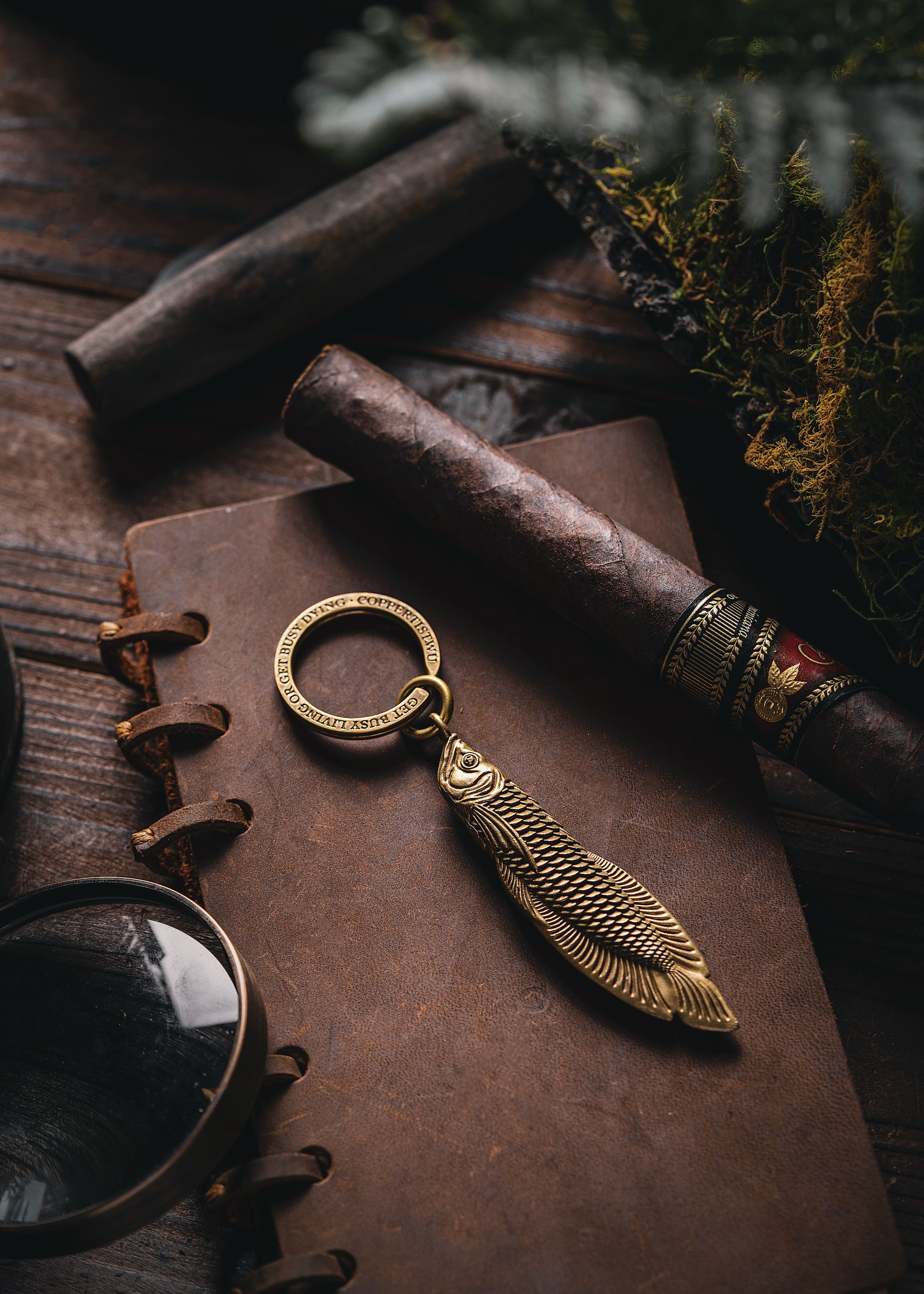 Cigar and Golden Fish on Vintage Notepad · Free Stock Photo