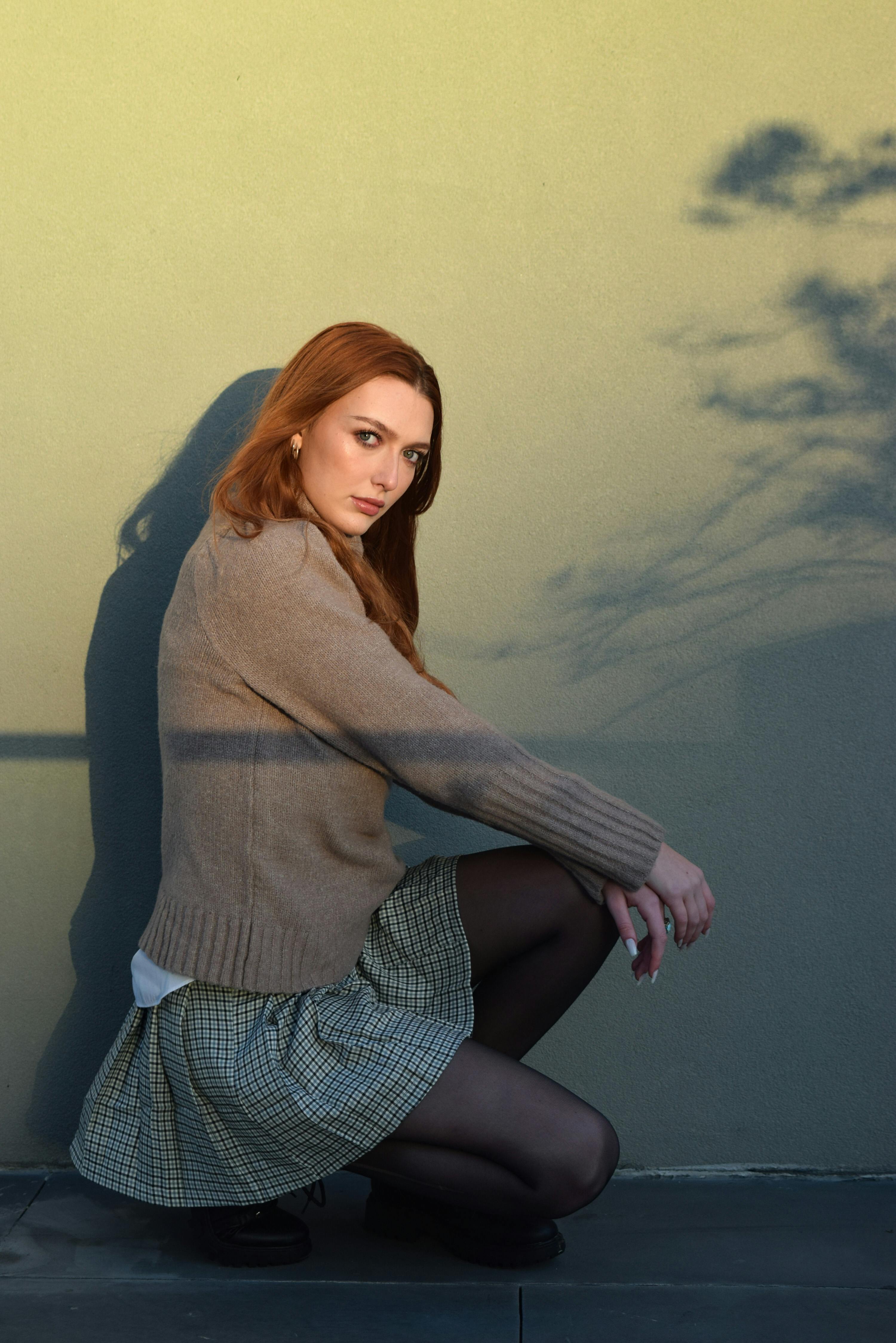 Woman Crouching and Posing · Free Stock Photo