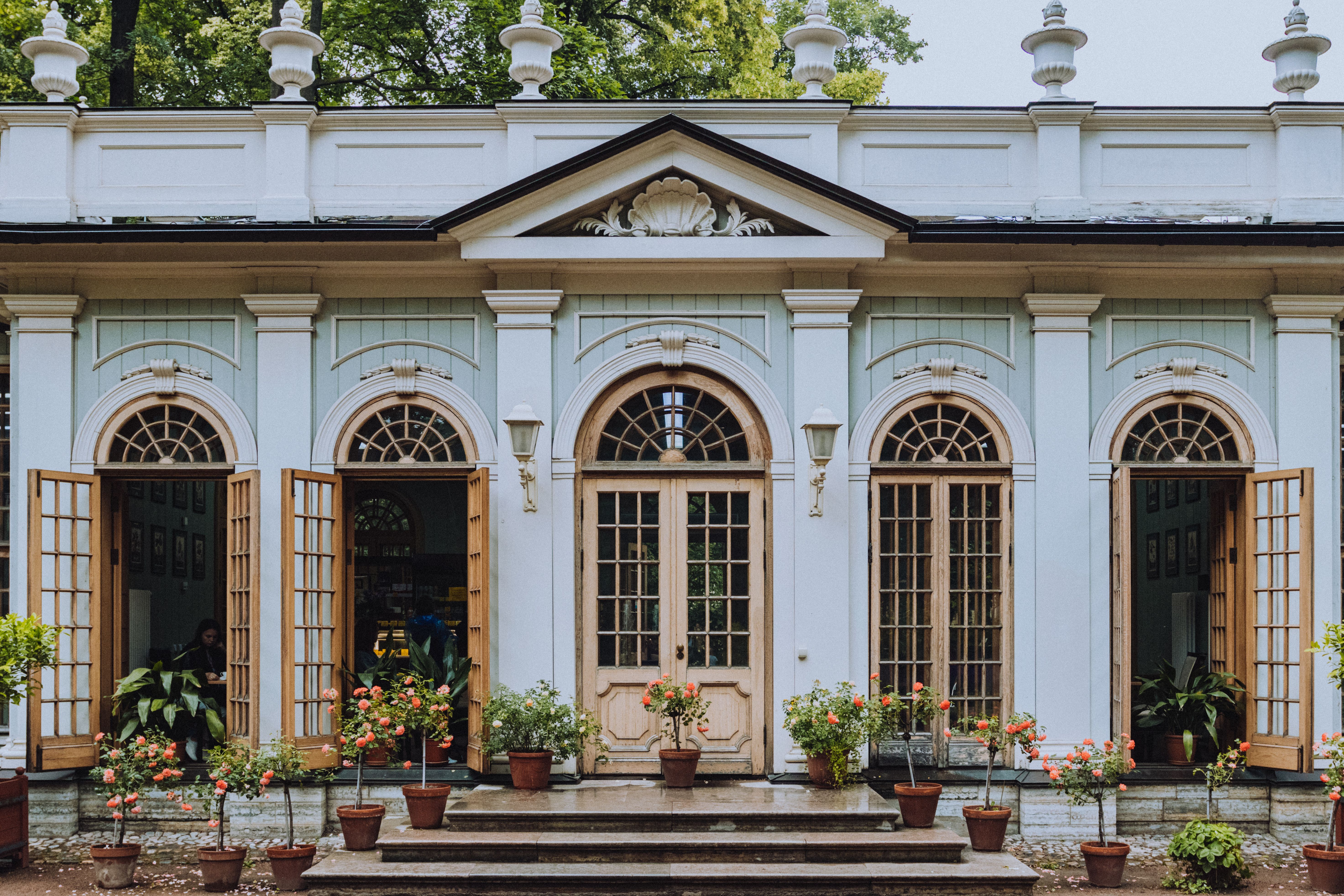 Flowers around Ornamented Building · Free Stock Photo