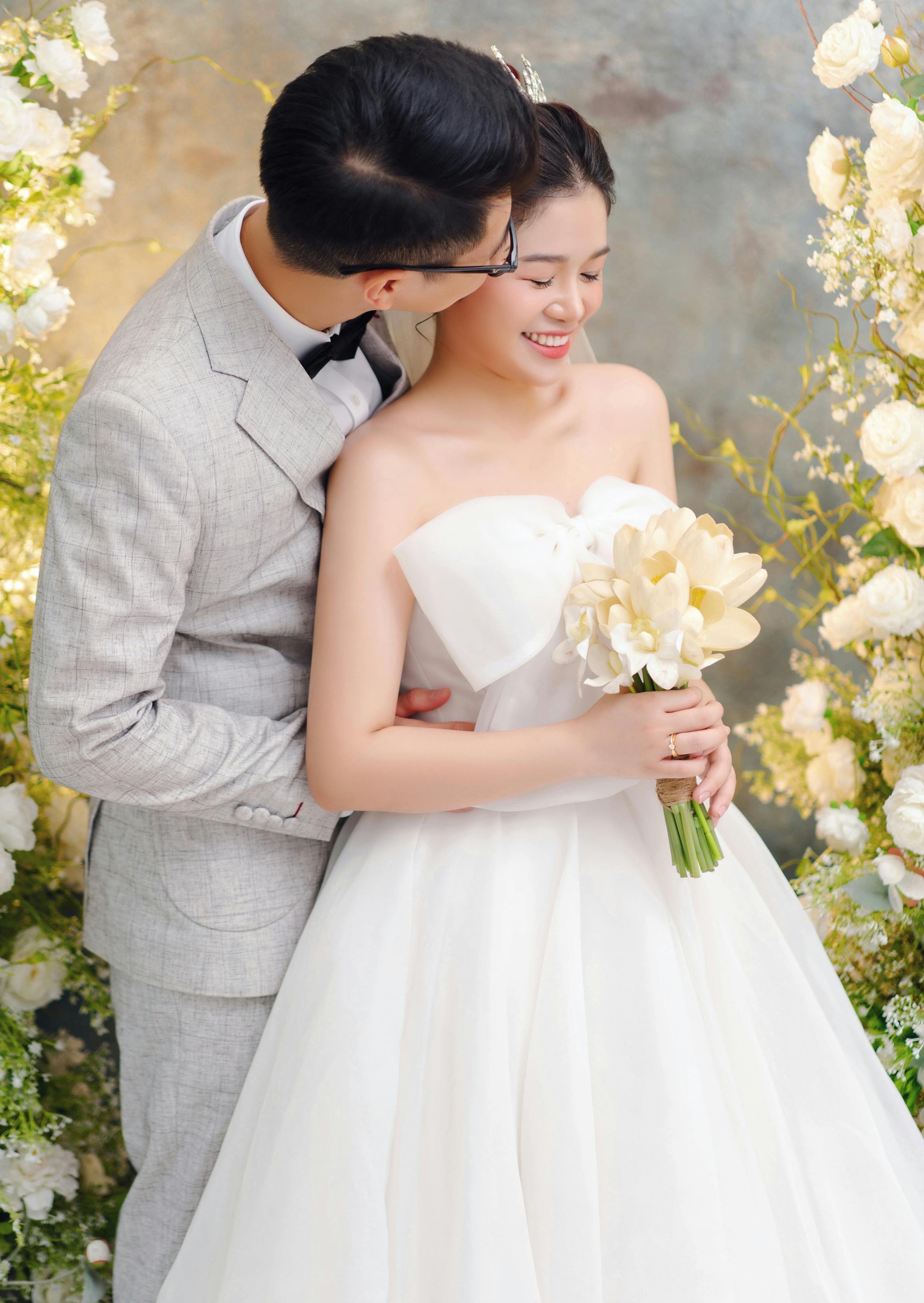 Bridegroom Kissing the Bride on the Cheek · Free Stock Photo