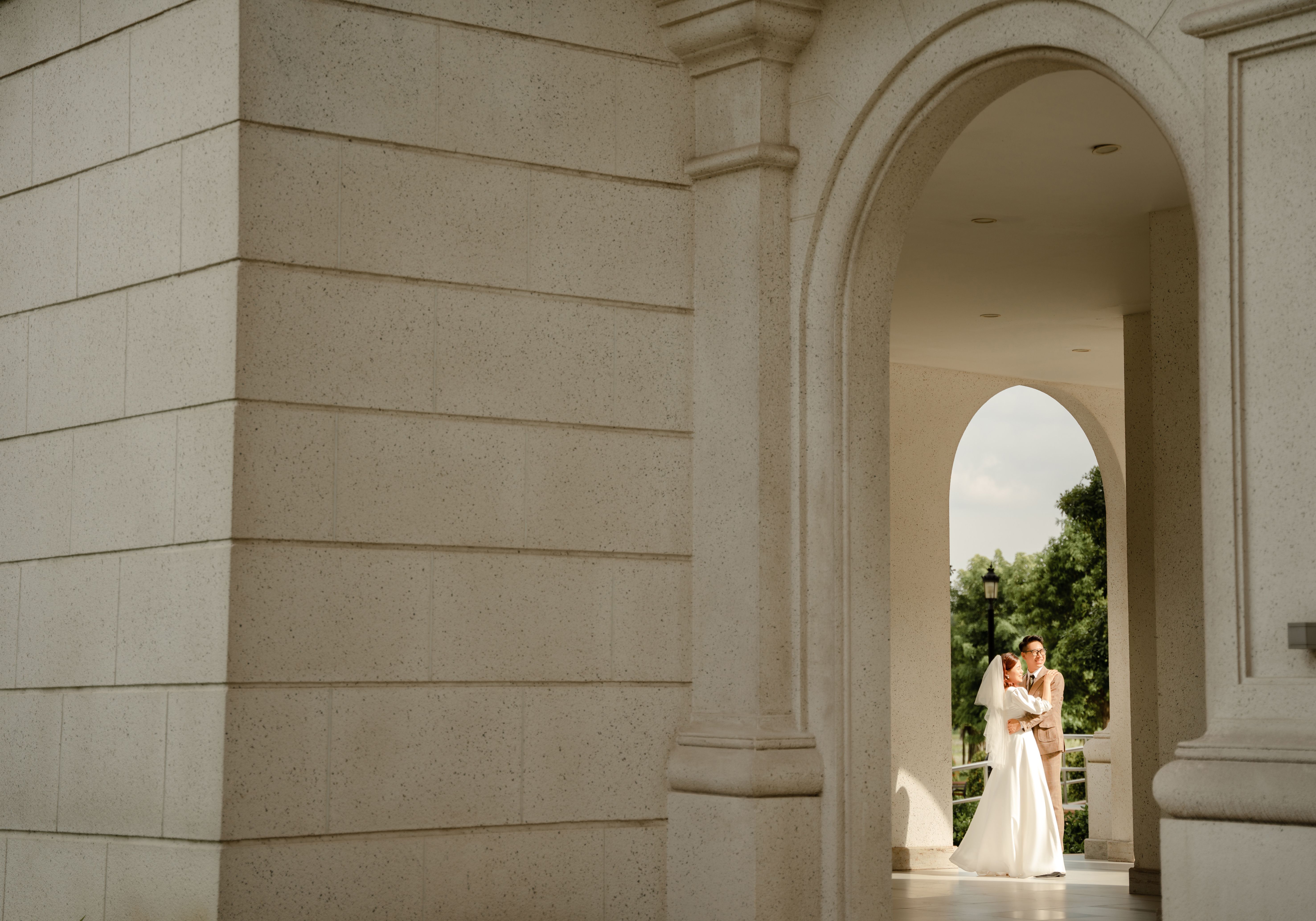 Loving Bride and Groom Posing Under Arch in Castle · Free Stock Photo