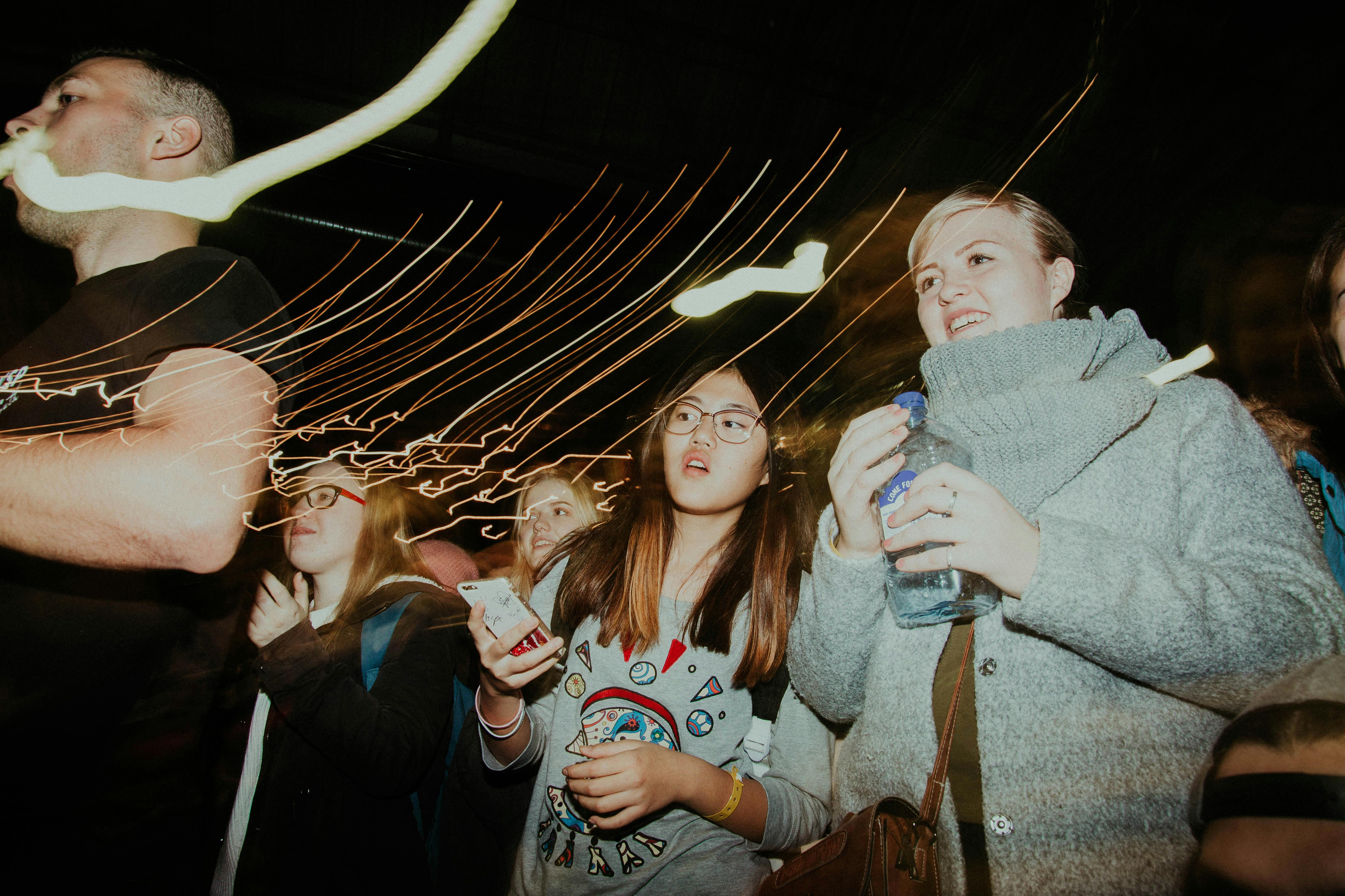 A Group of Young People Watching a Performance Outdoors · Free Stock Photo