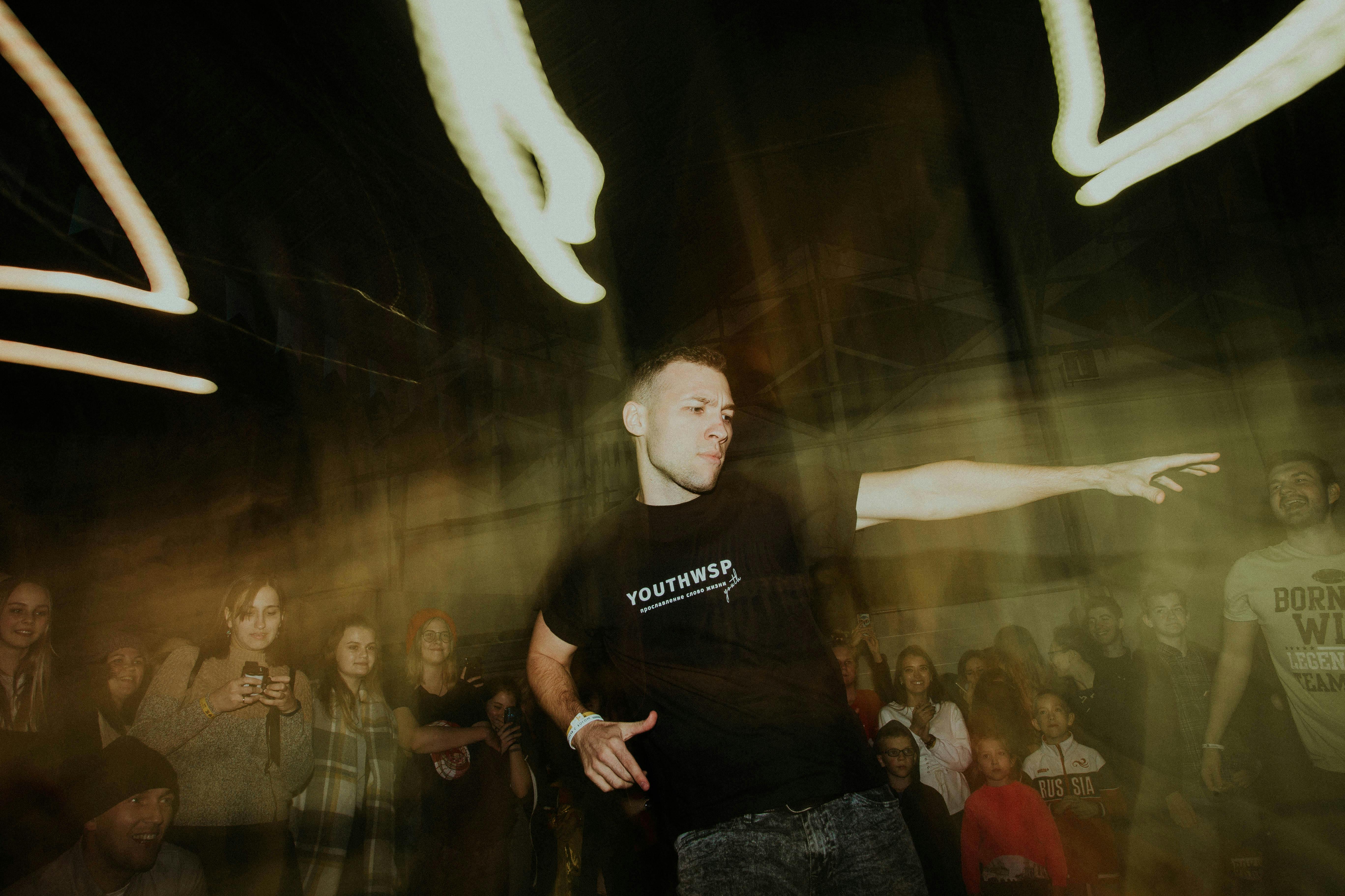 A Group of Young People Watching a Man Dance · Free Stock Photo