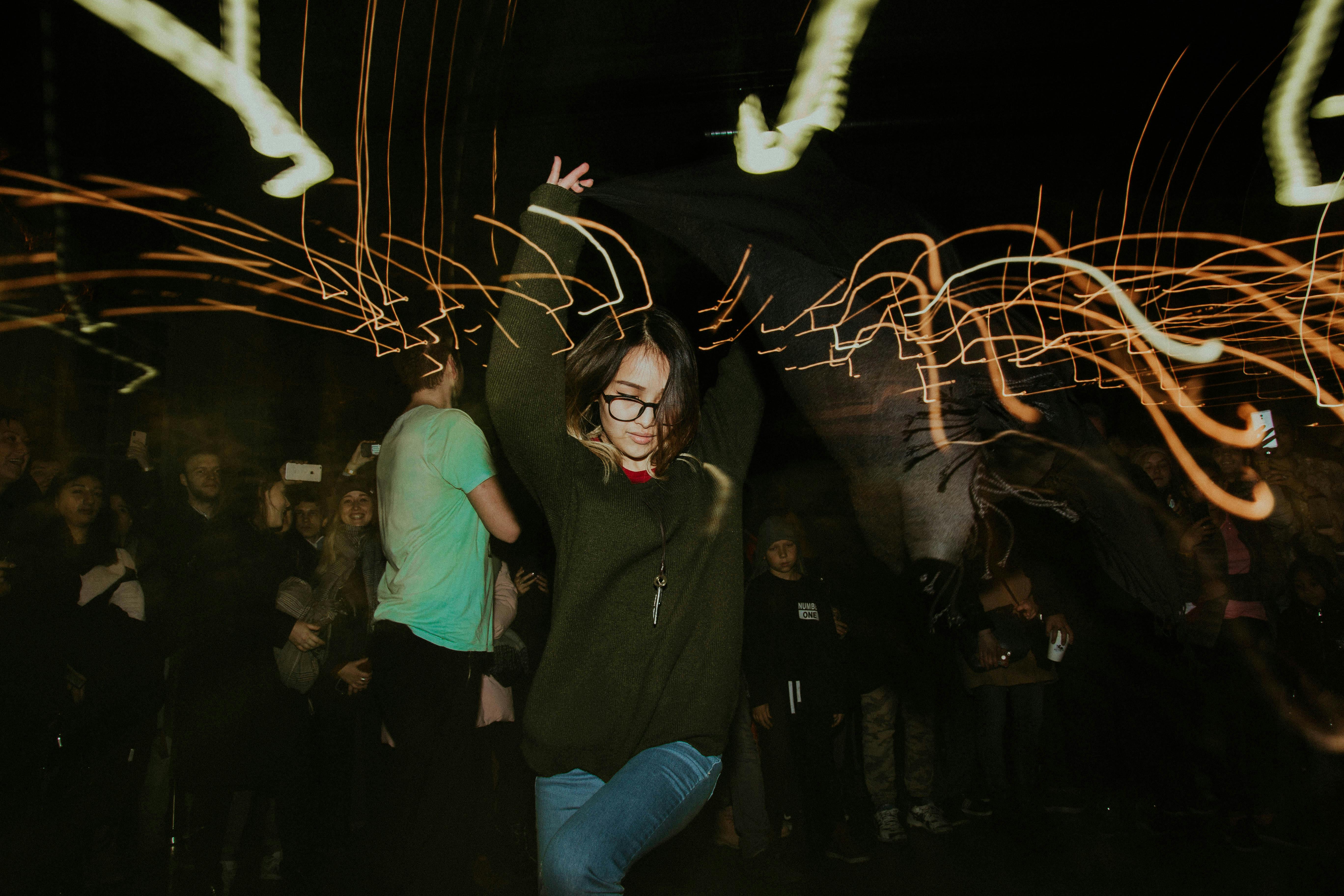 A Group of Young People Watching a Man Dance · Free Stock Photo