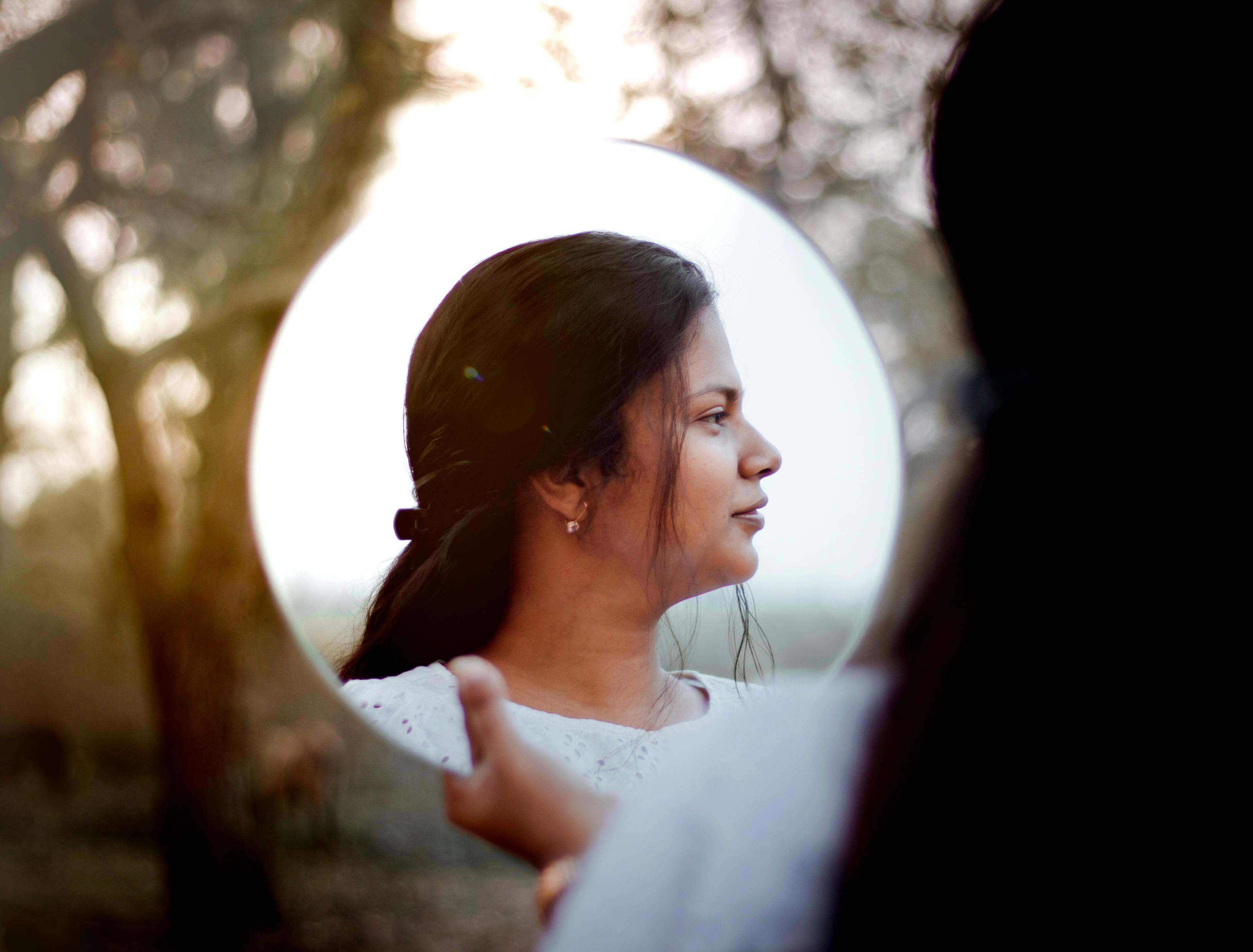 Woman standing Over a Mirror Outside · Free Stock Photo