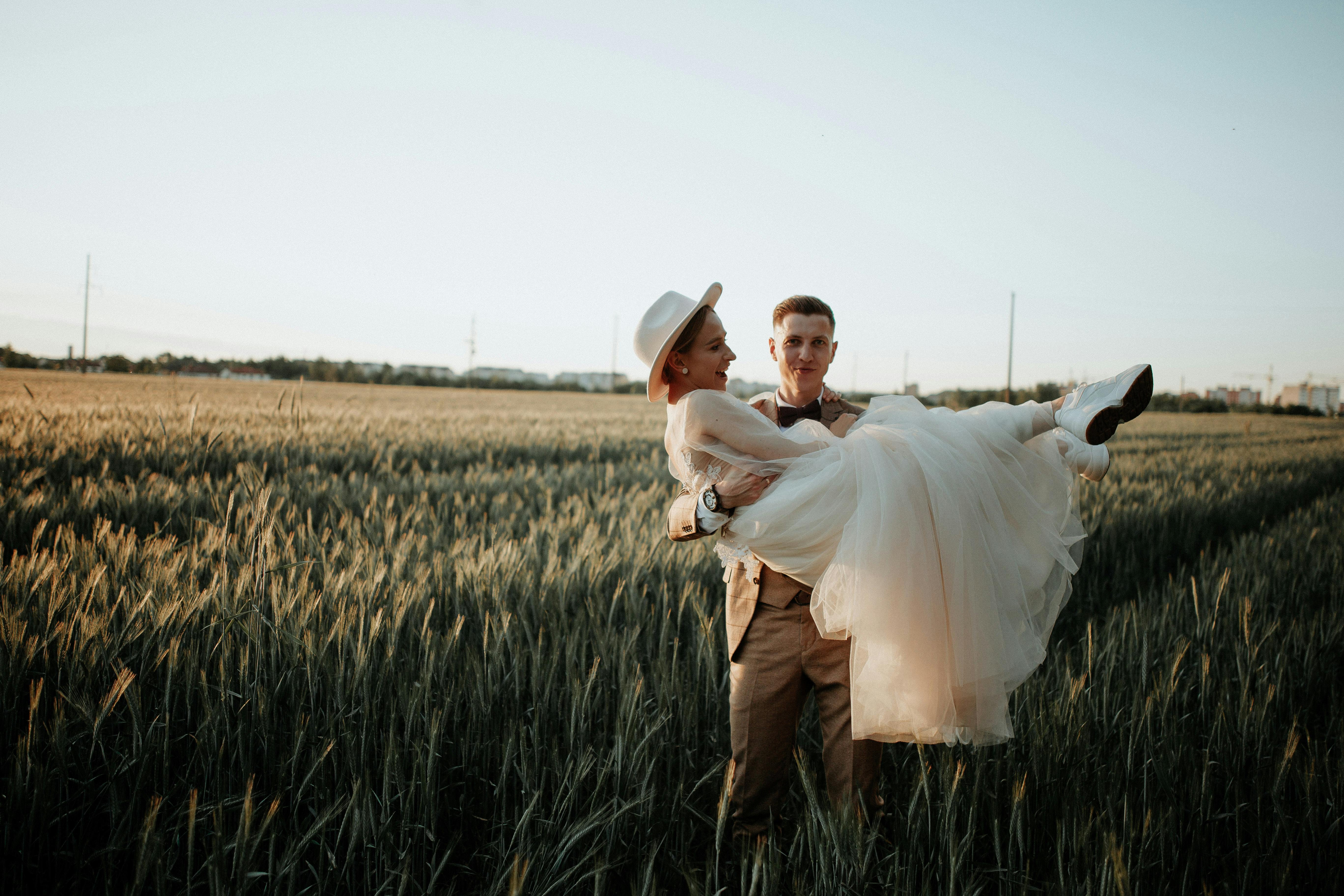 Groom Holding Bride · Free Stock Photo