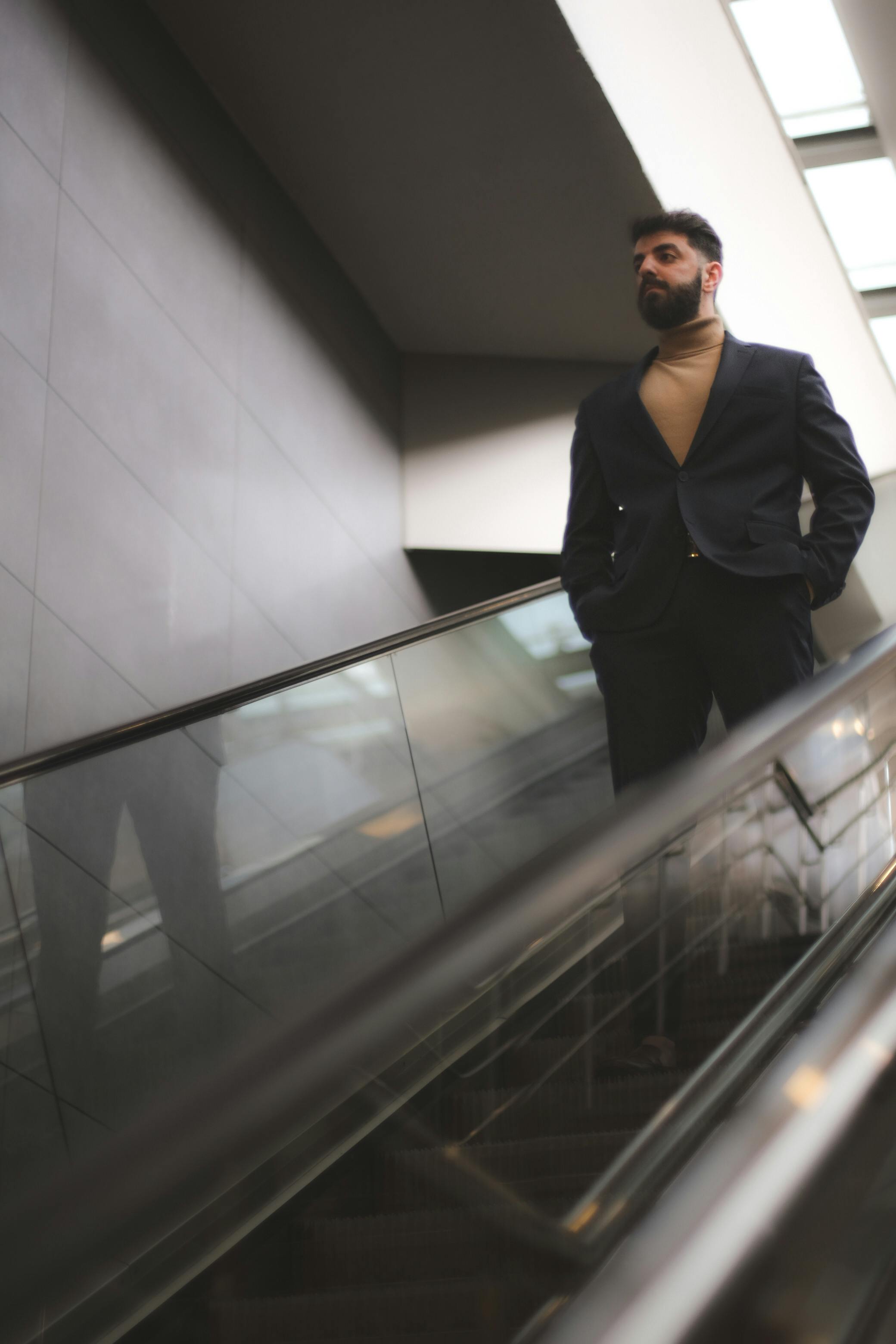 Man In Grey Suit Standing On Stair · Free Stock Photo