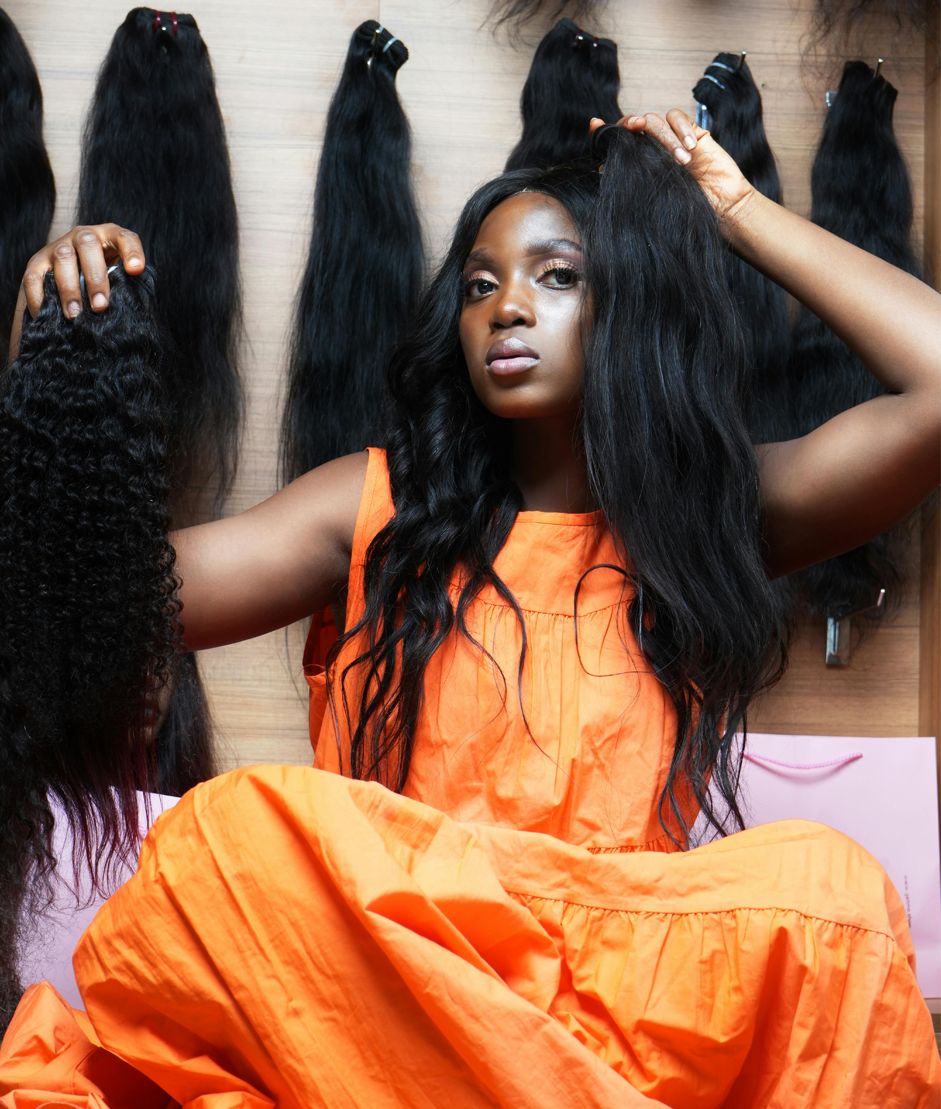 Young Woman Trying Different Wigs · Free Stock Photo