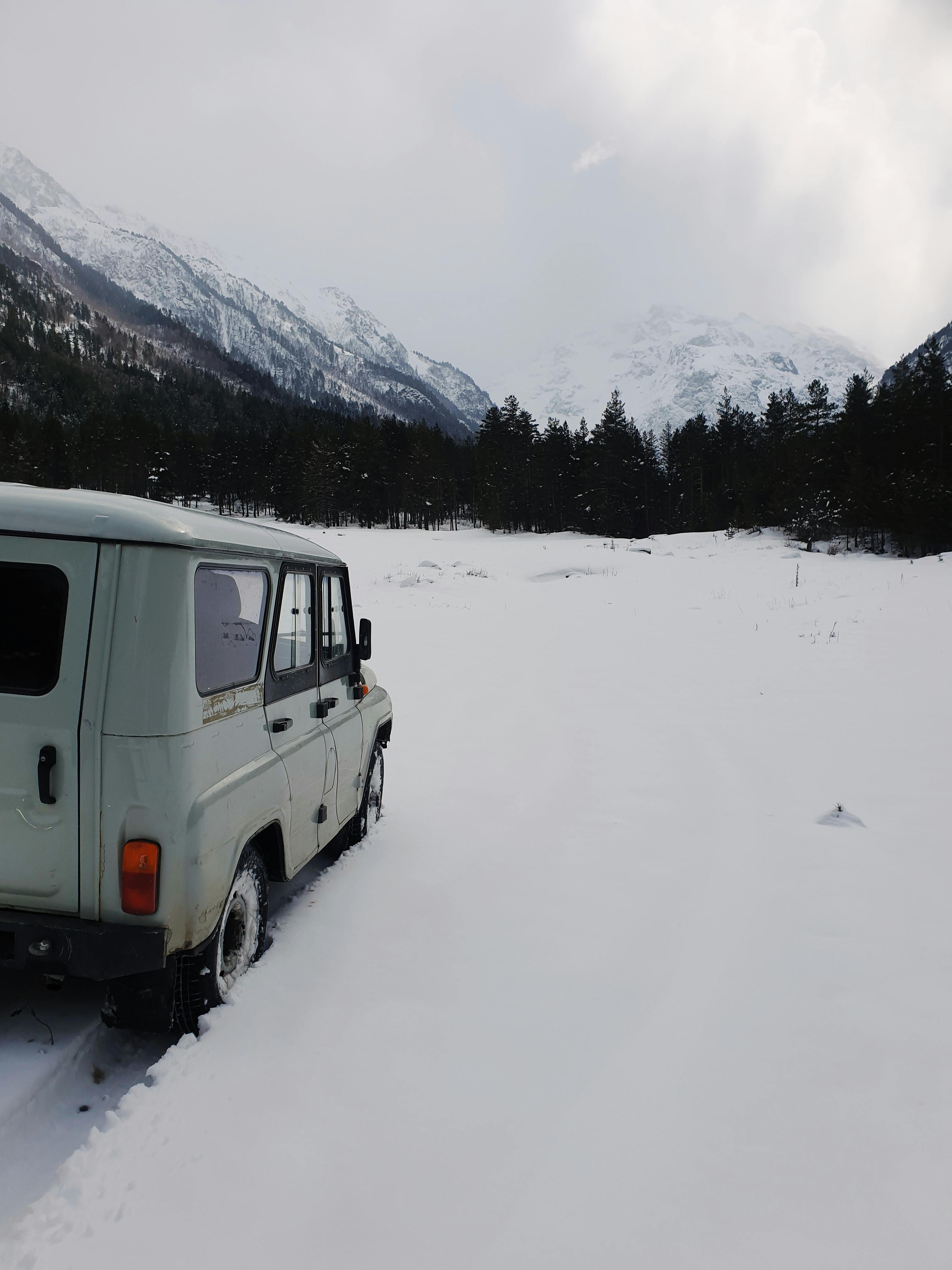 Car on Snow with Forest behind · Free Stock Photo