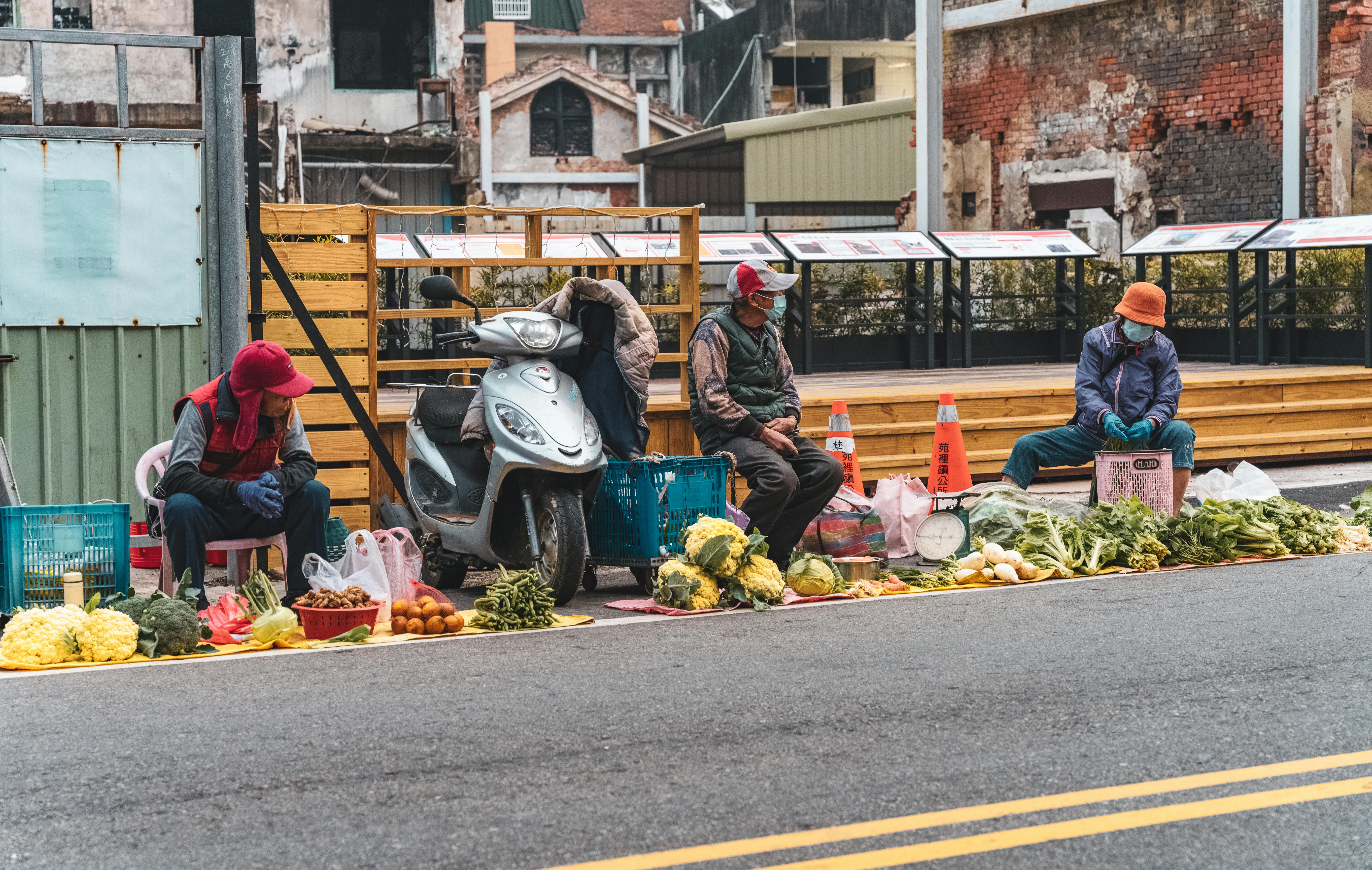 Street Vendors Sitting by Street · Free Stock Photo