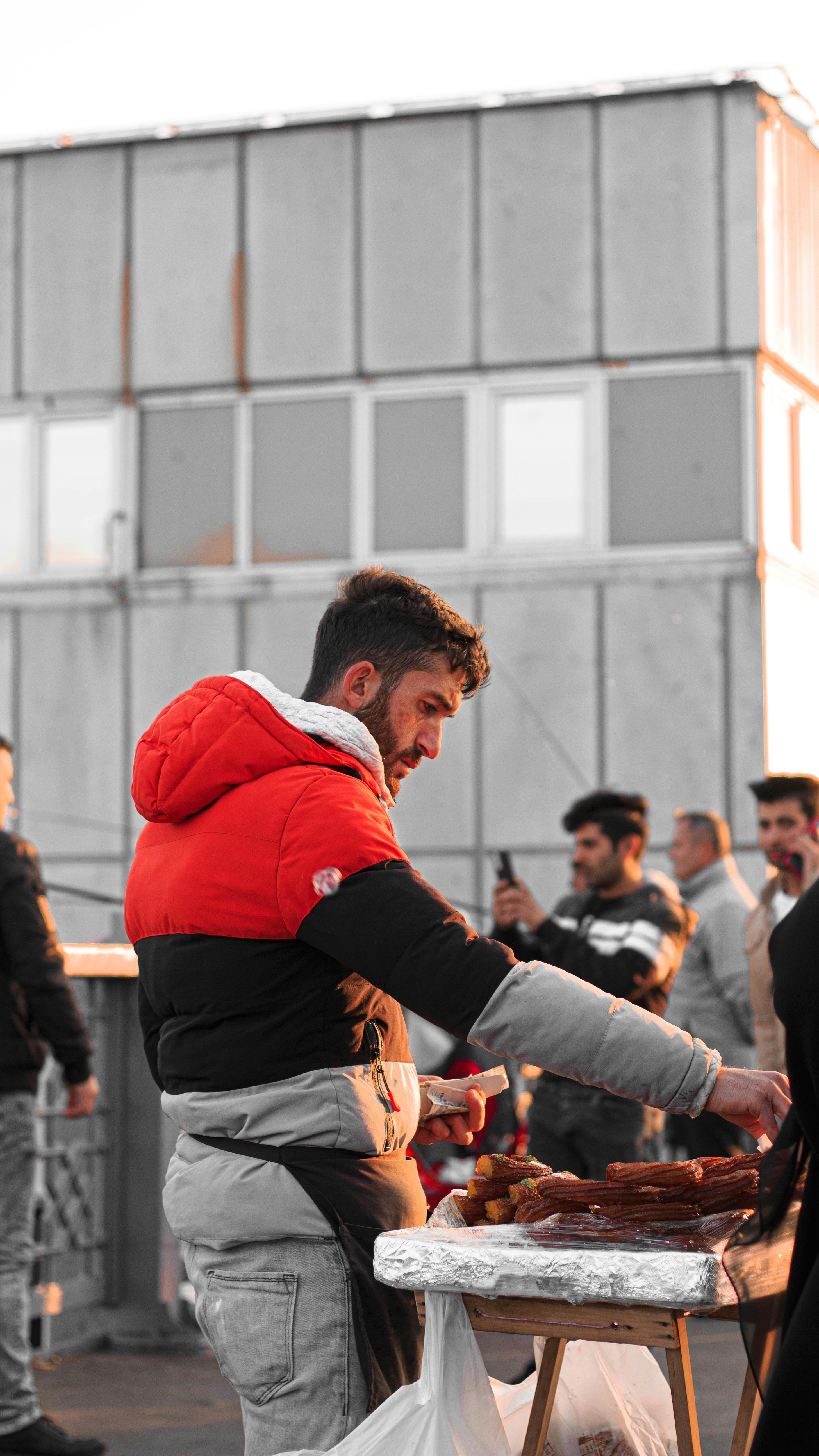 Man Roasting Food at a Stand in the Street · Free Stock Photo